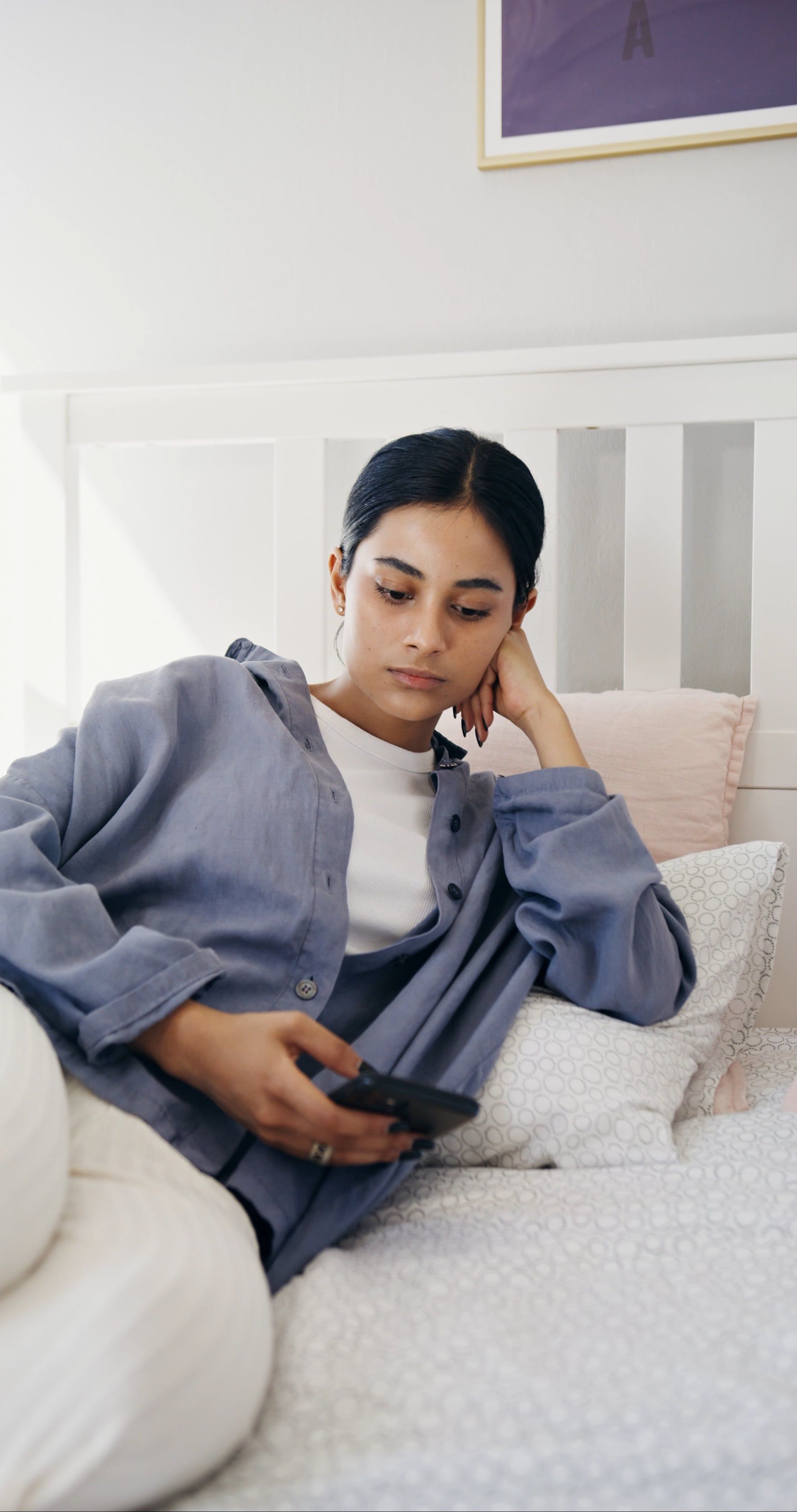 A Woman Using Her Cellphone While Lying Down on Bed · Free Stock Video