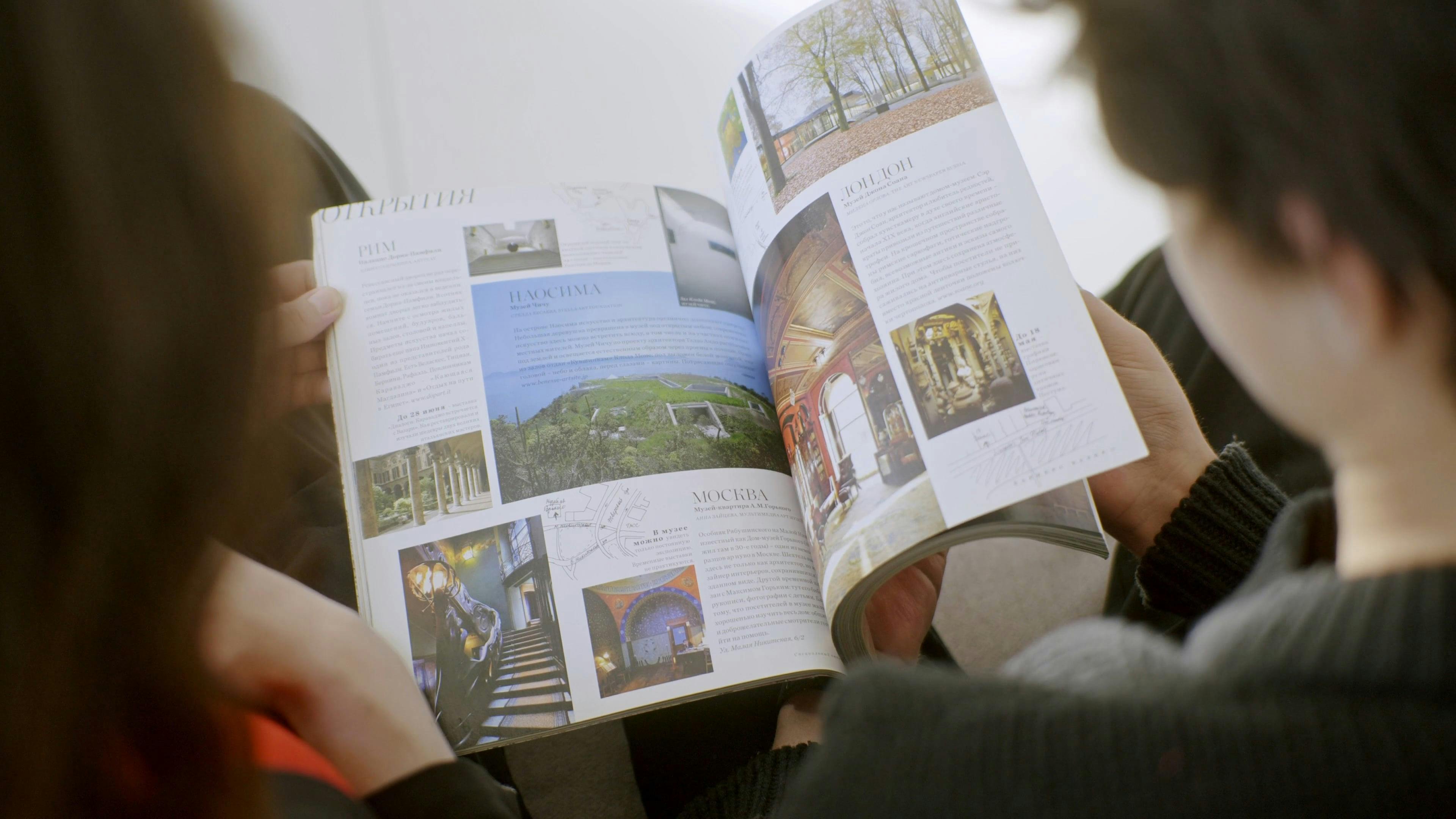 People Looking at a Magazine · Free Stock Video