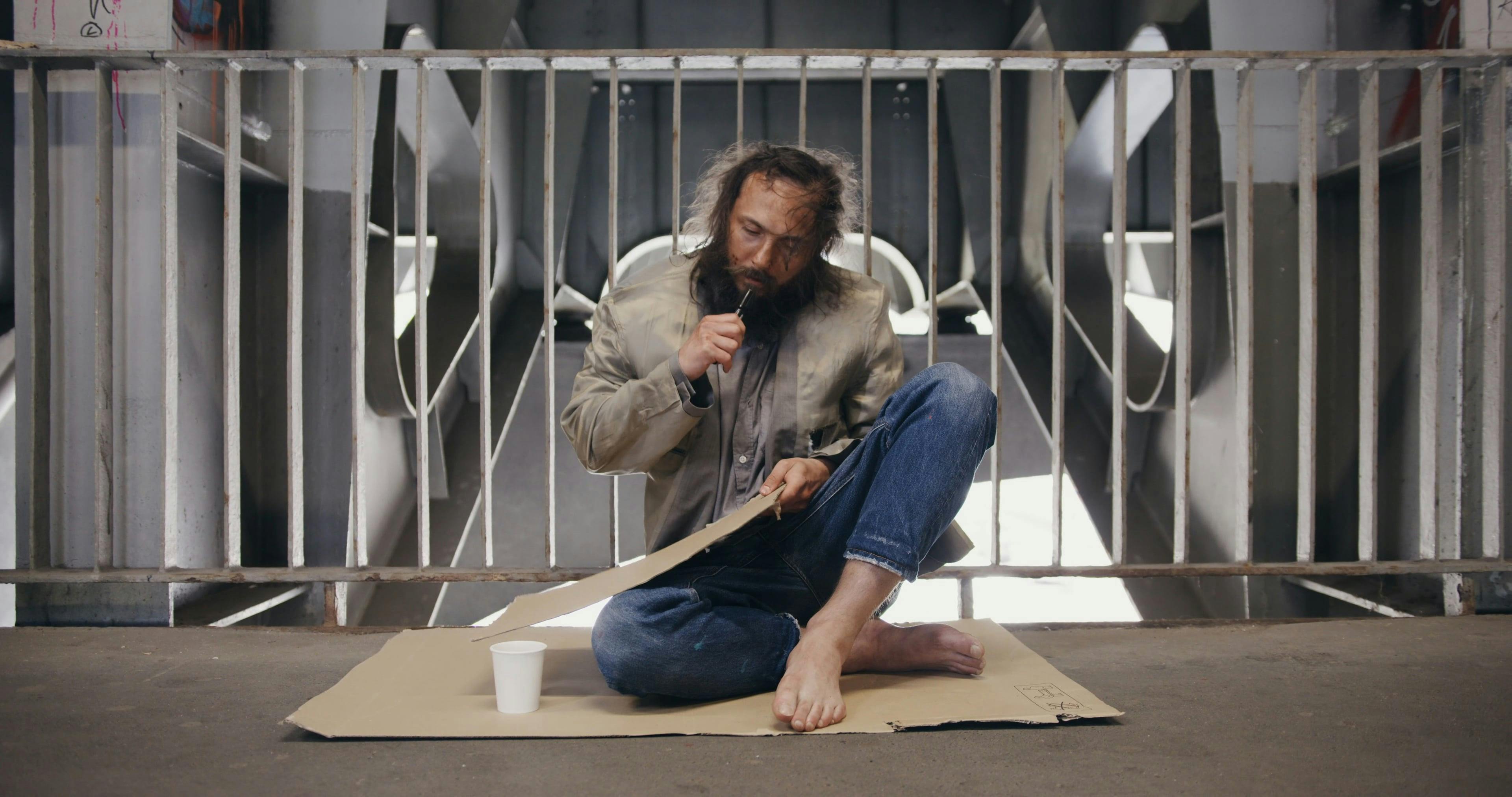 Homeless Writing In The Cardboard · Free Stock Video