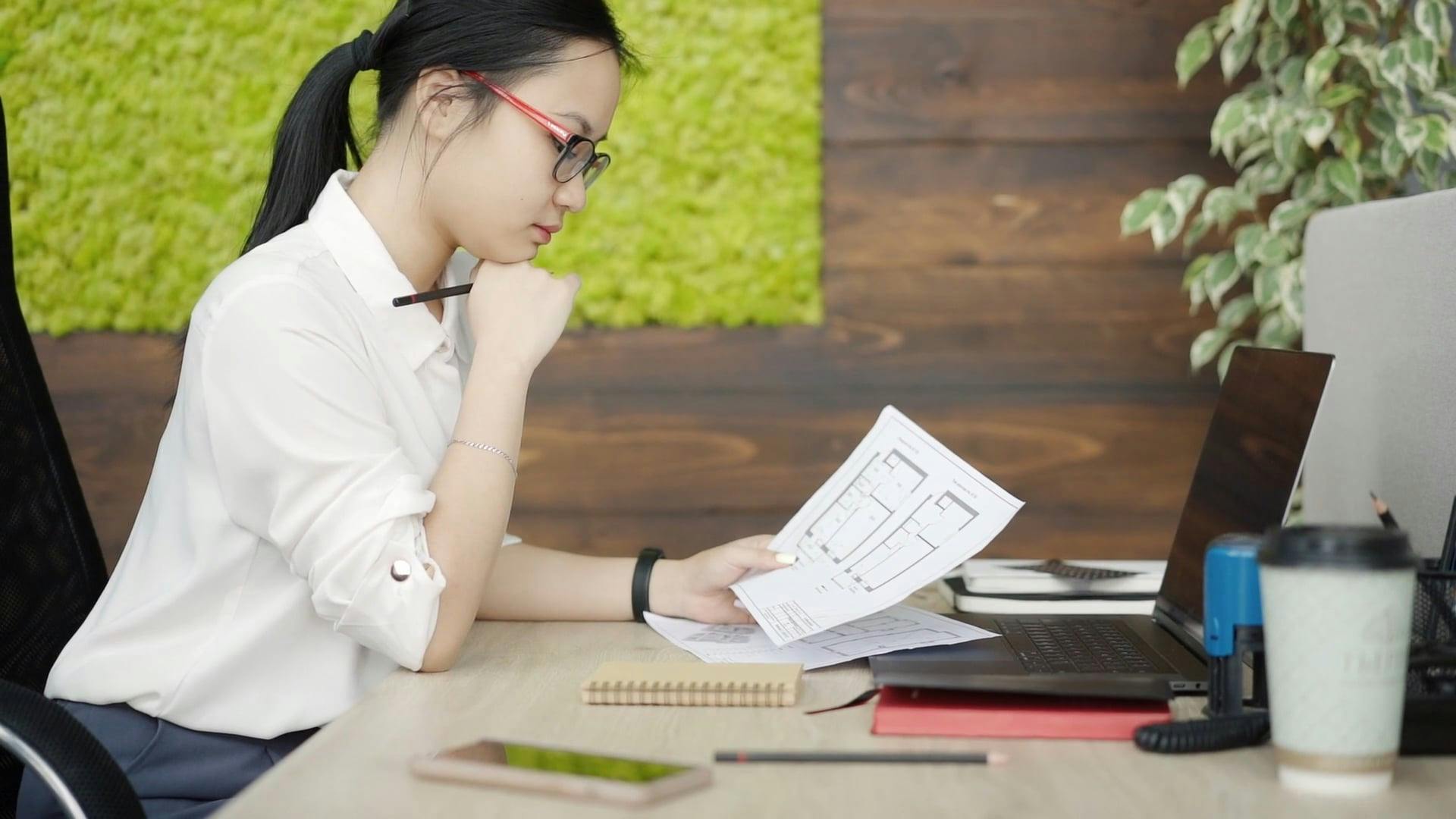 A Woman Reading a Paper Then Smiling and Posing in the Camera · Free ...