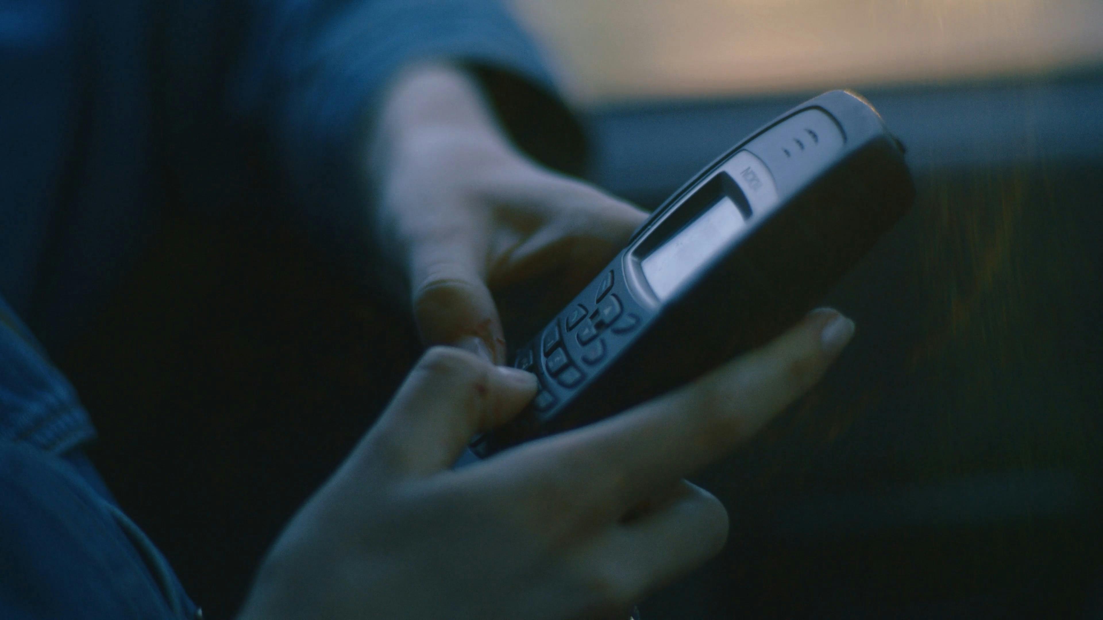 A Woman Using an Old Cell Phone · Free Stock Video