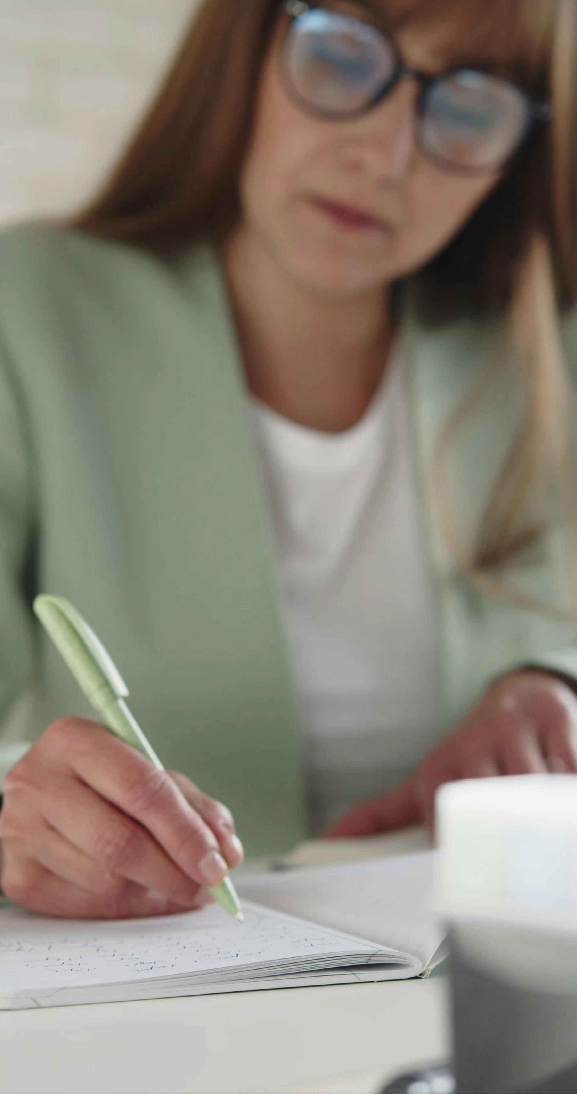 Woman Writing on Her Notebook · Free Stock Video