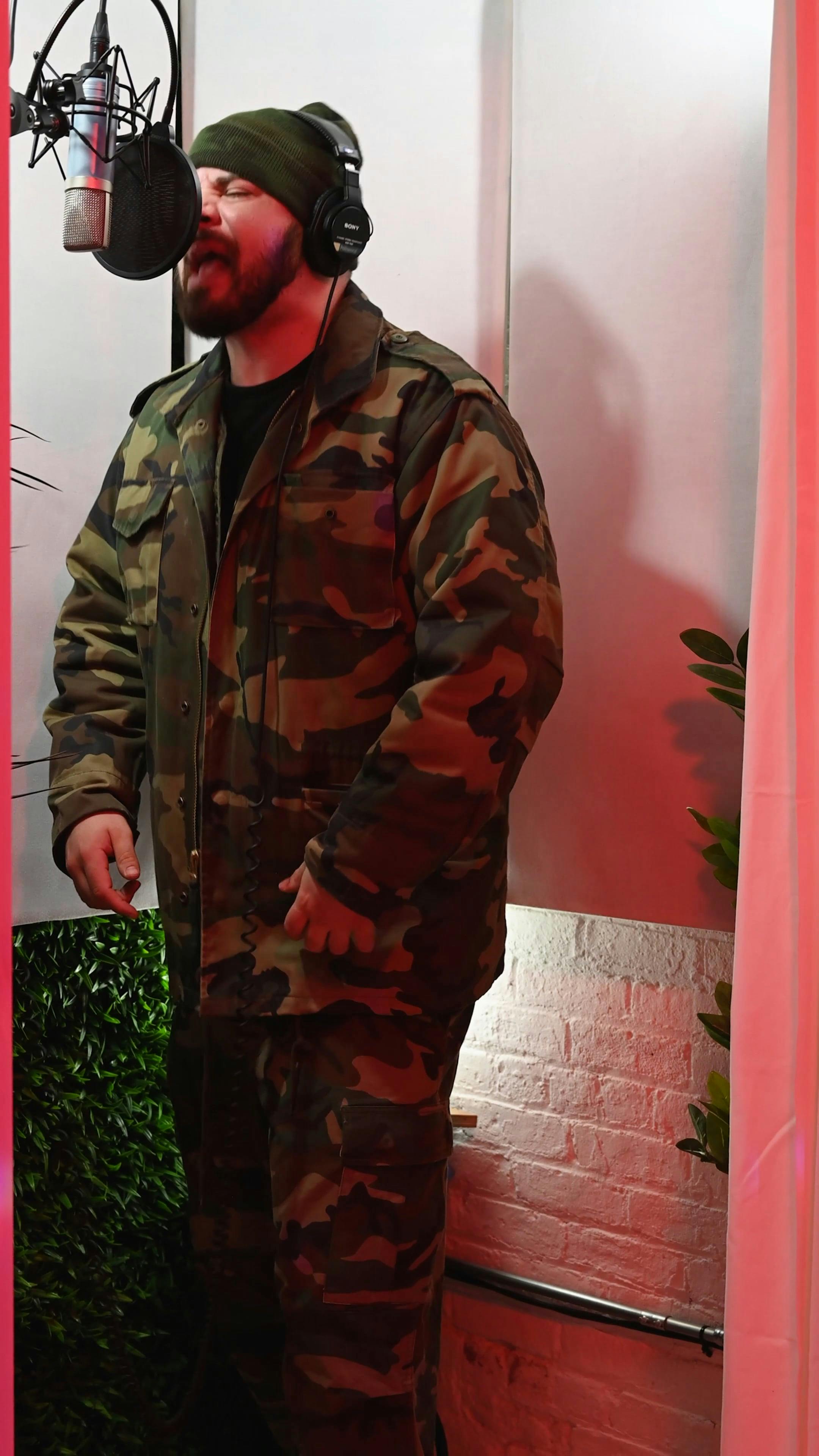 Man Wearing Camouflage Singing In A Studio With A Condenser Mic · Free ...