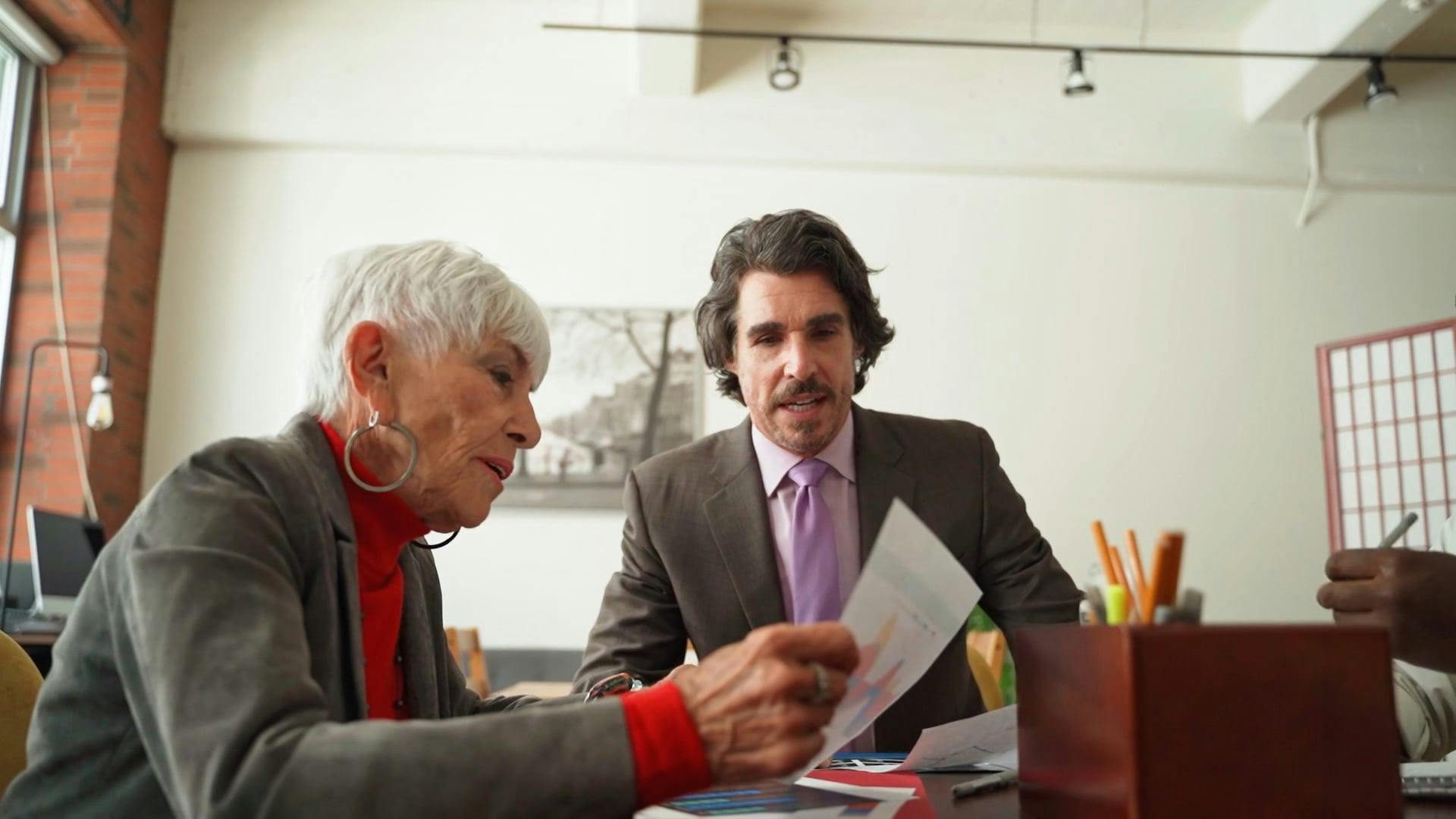 An Elderly Woman Explaining the Document to a Business Man · Free Stock ...
