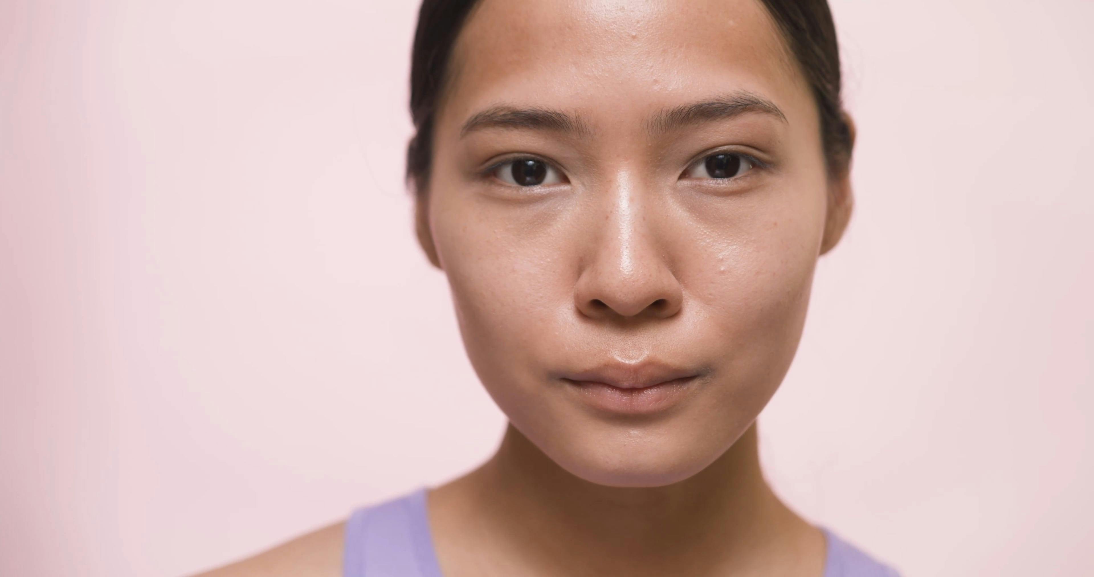 Close-Up Video of Woman Using Facial Roller on her Face Free Stock ...