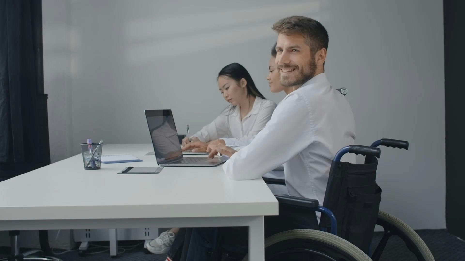 A Woman In A Wheelchair Working With A Laptop In The Office · Free ...