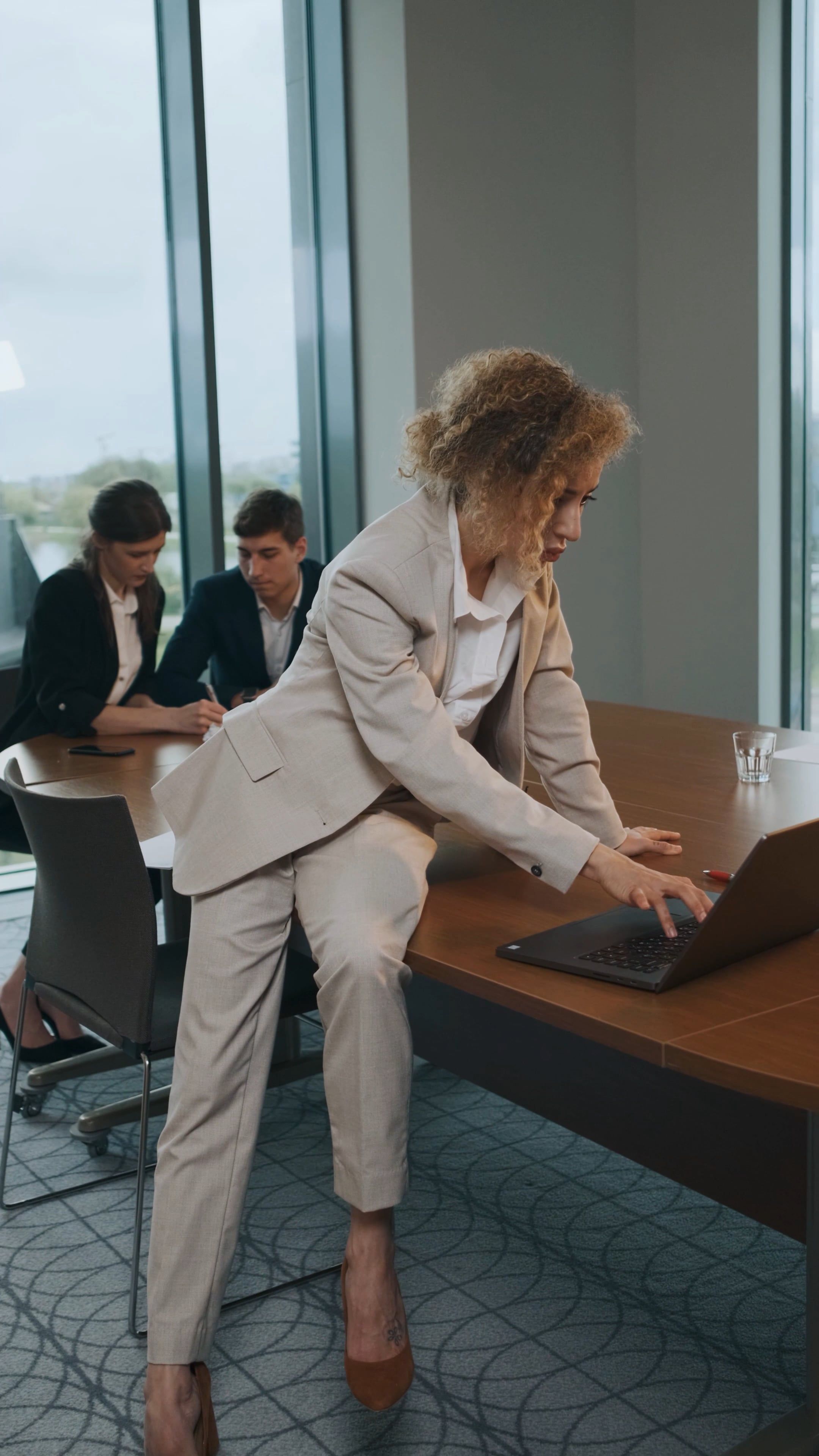 A Businesswoman Sitting on the Table while using Laptop · Free Stock Video