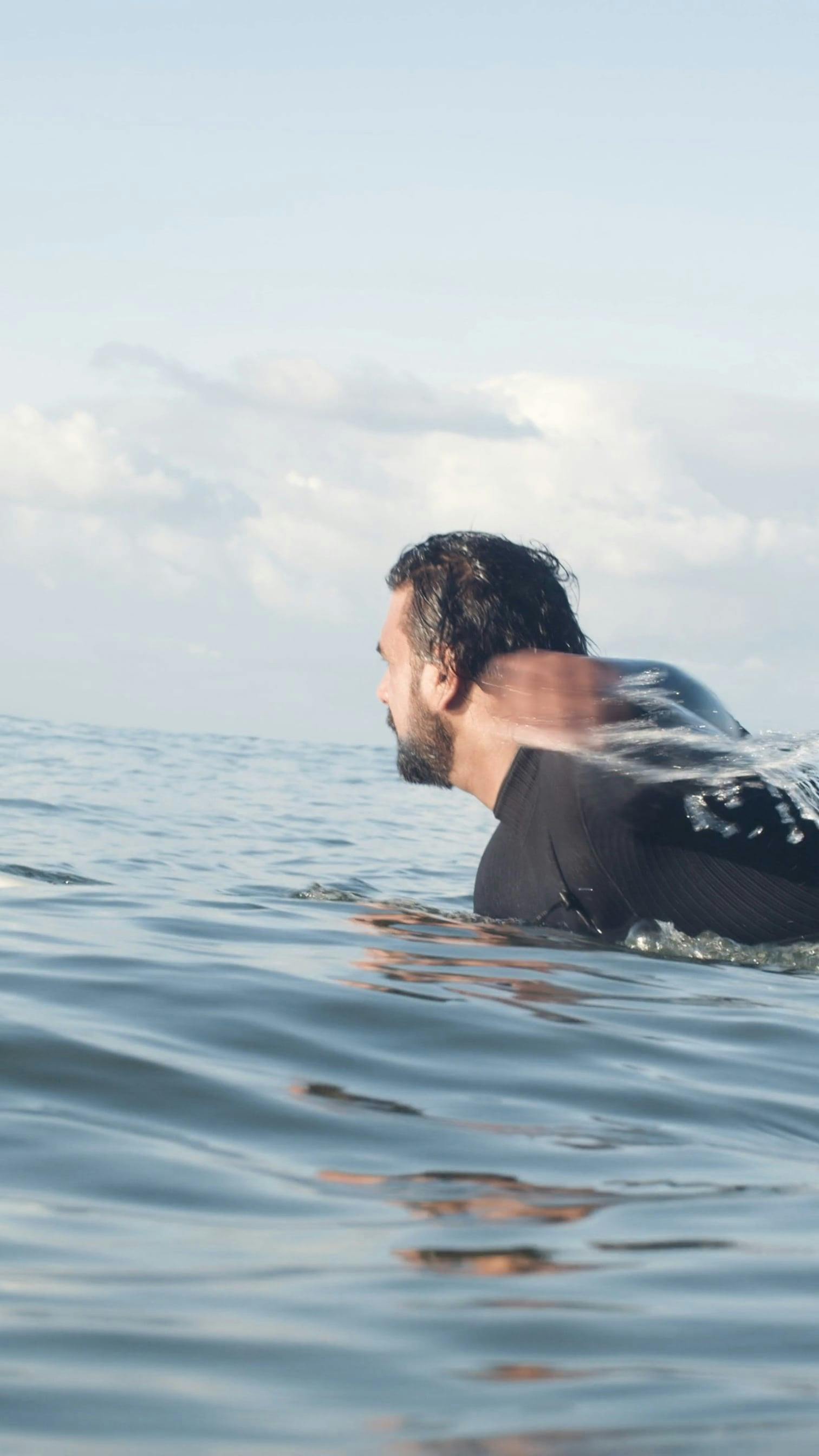 A Man Paddling while using a Surfboard · Free Stock Video