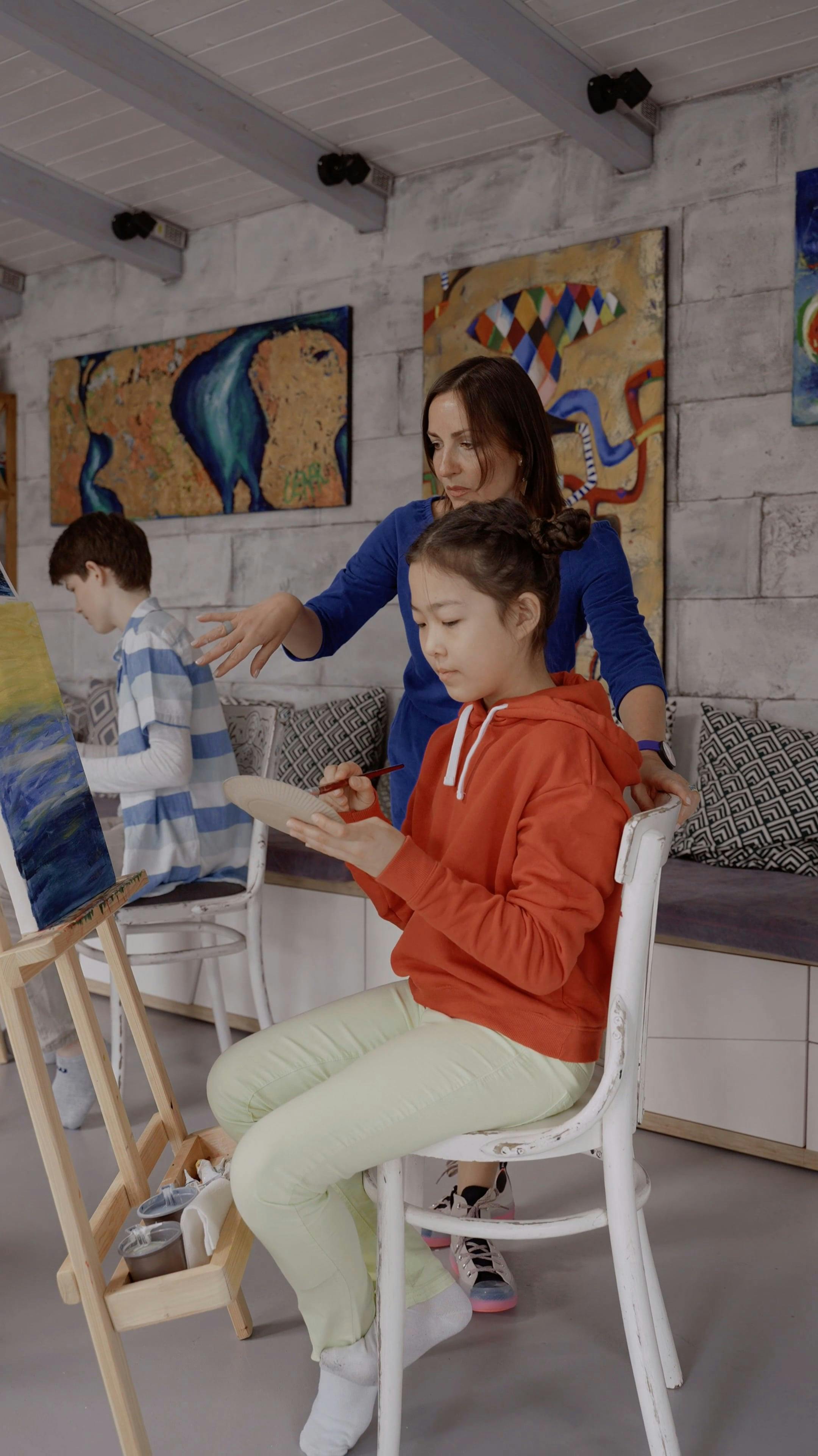 A Woman Teaching a Girl How to Paint · Free Stock Video