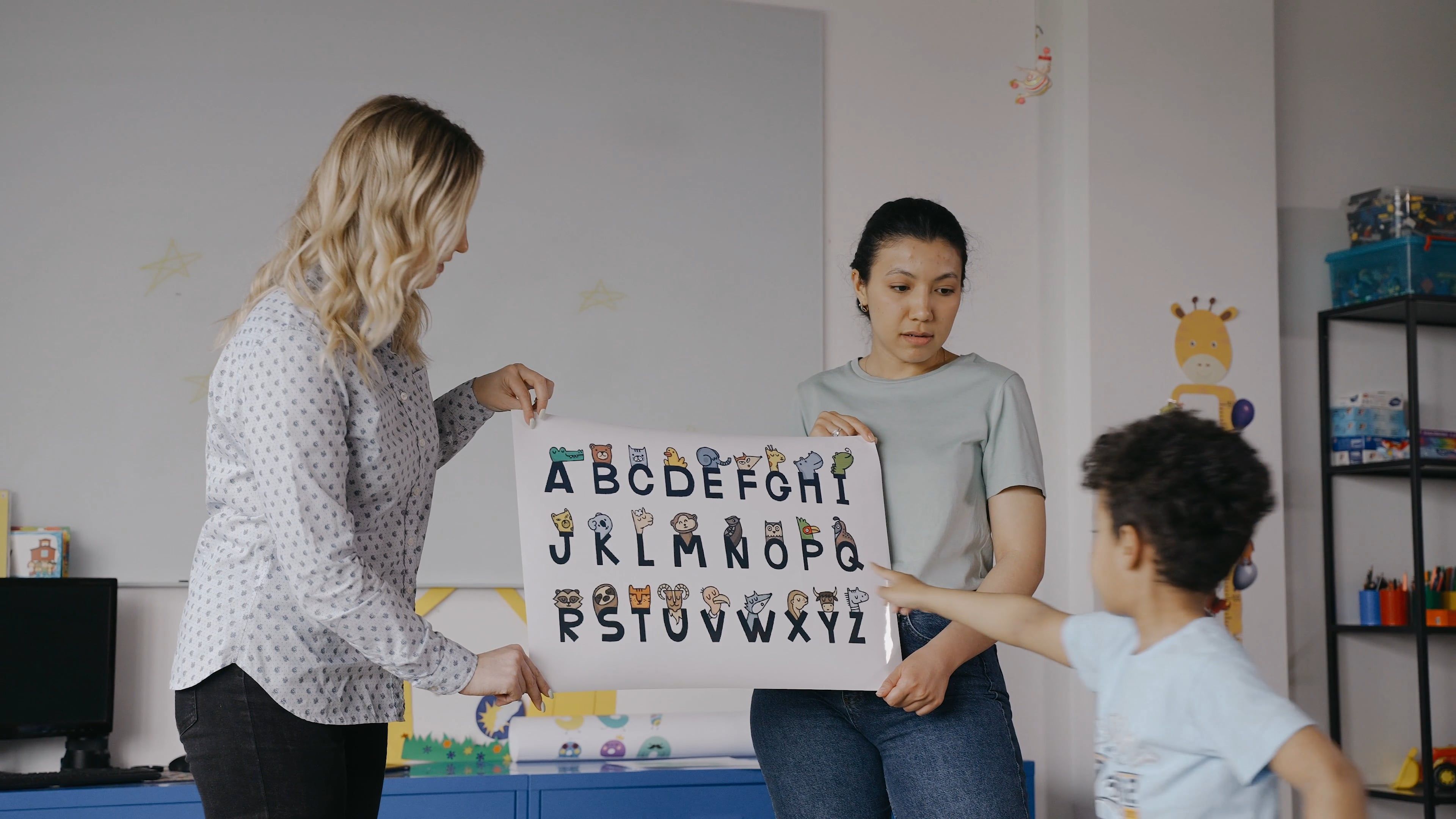 Children Pointing the Letter from the Chart Handheld by the Teachers ...