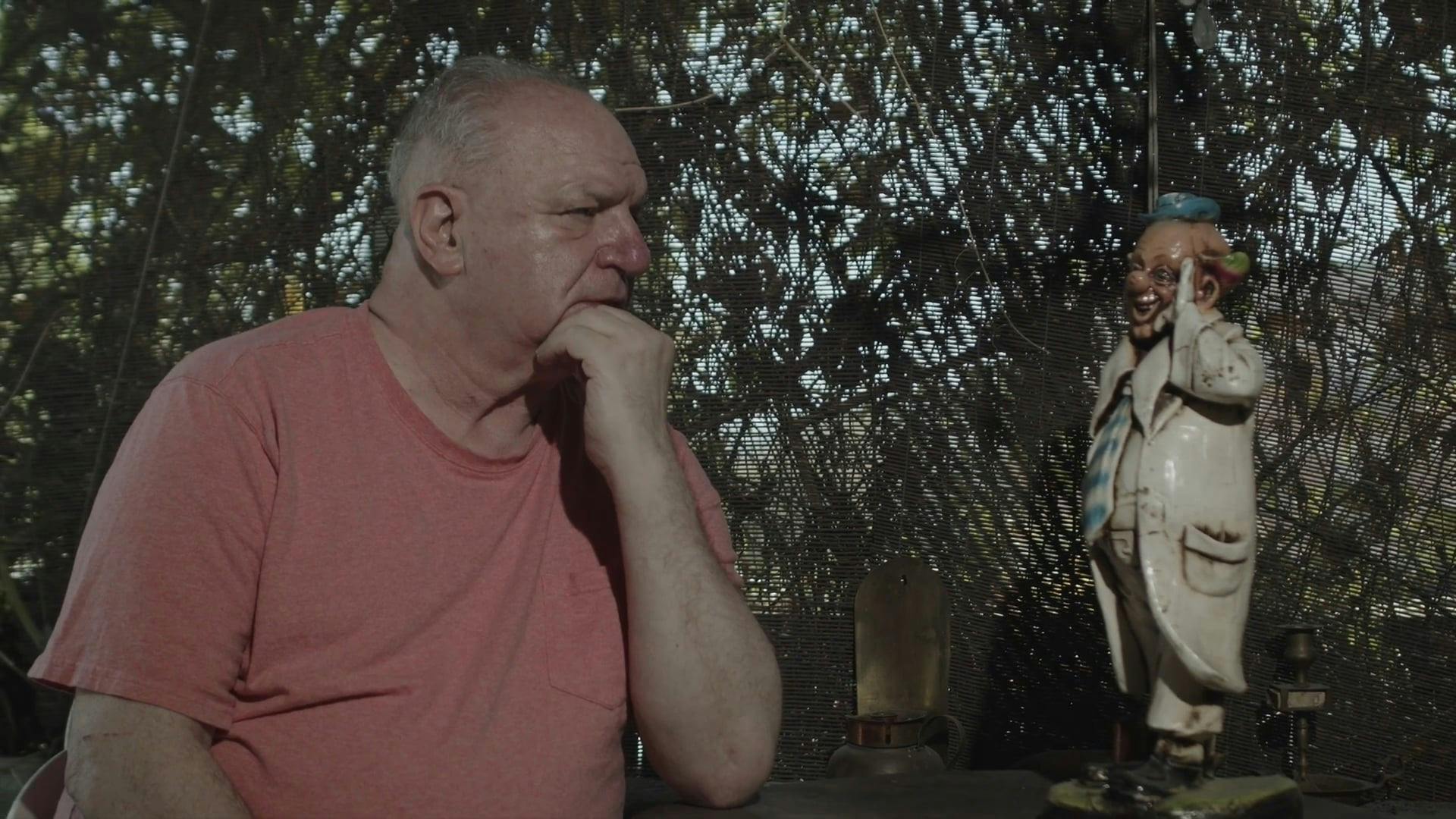 An Elderly Man Staring at a Clown Figurine Free Stock Video Footage ...