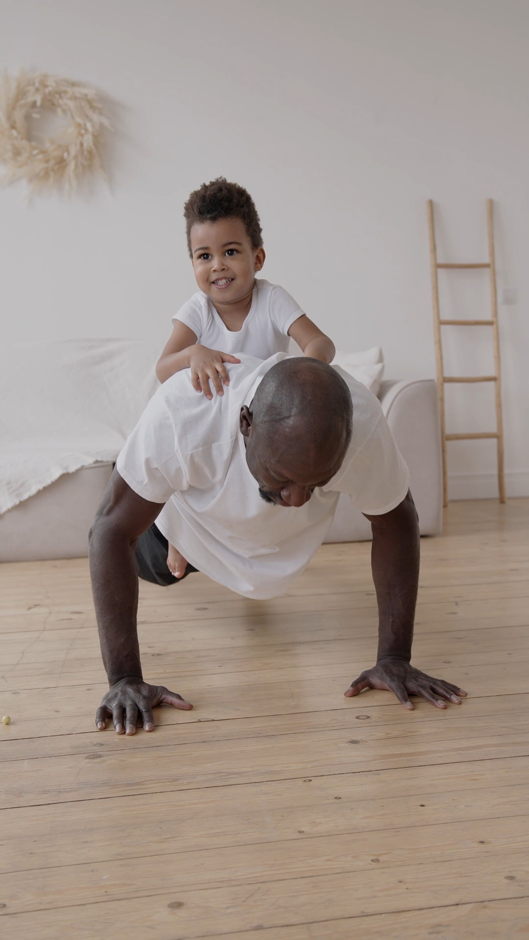 A Man Doing Push Ups with a Little Boy on his Back · Free Stock Video