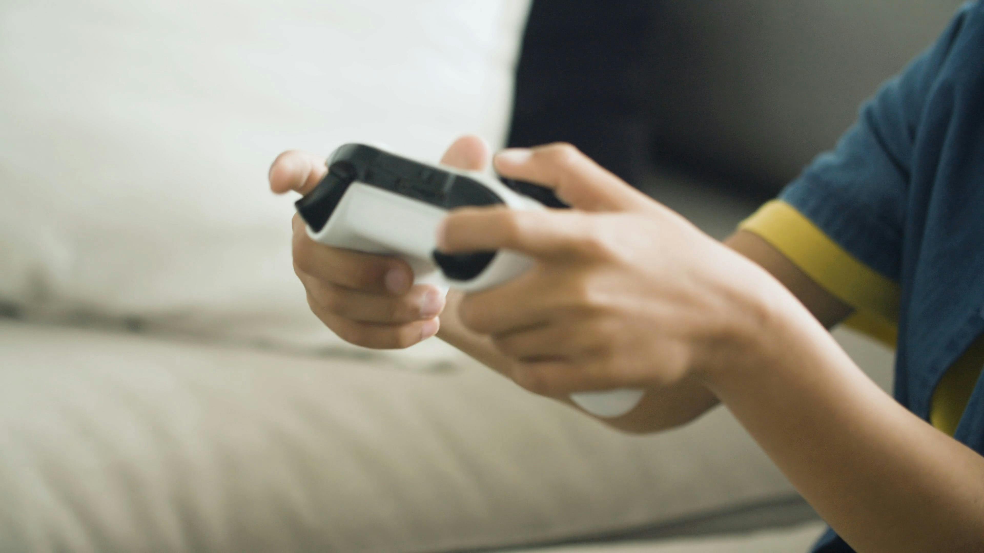 A Child Using a Wireless Game Controller · Free Stock Video