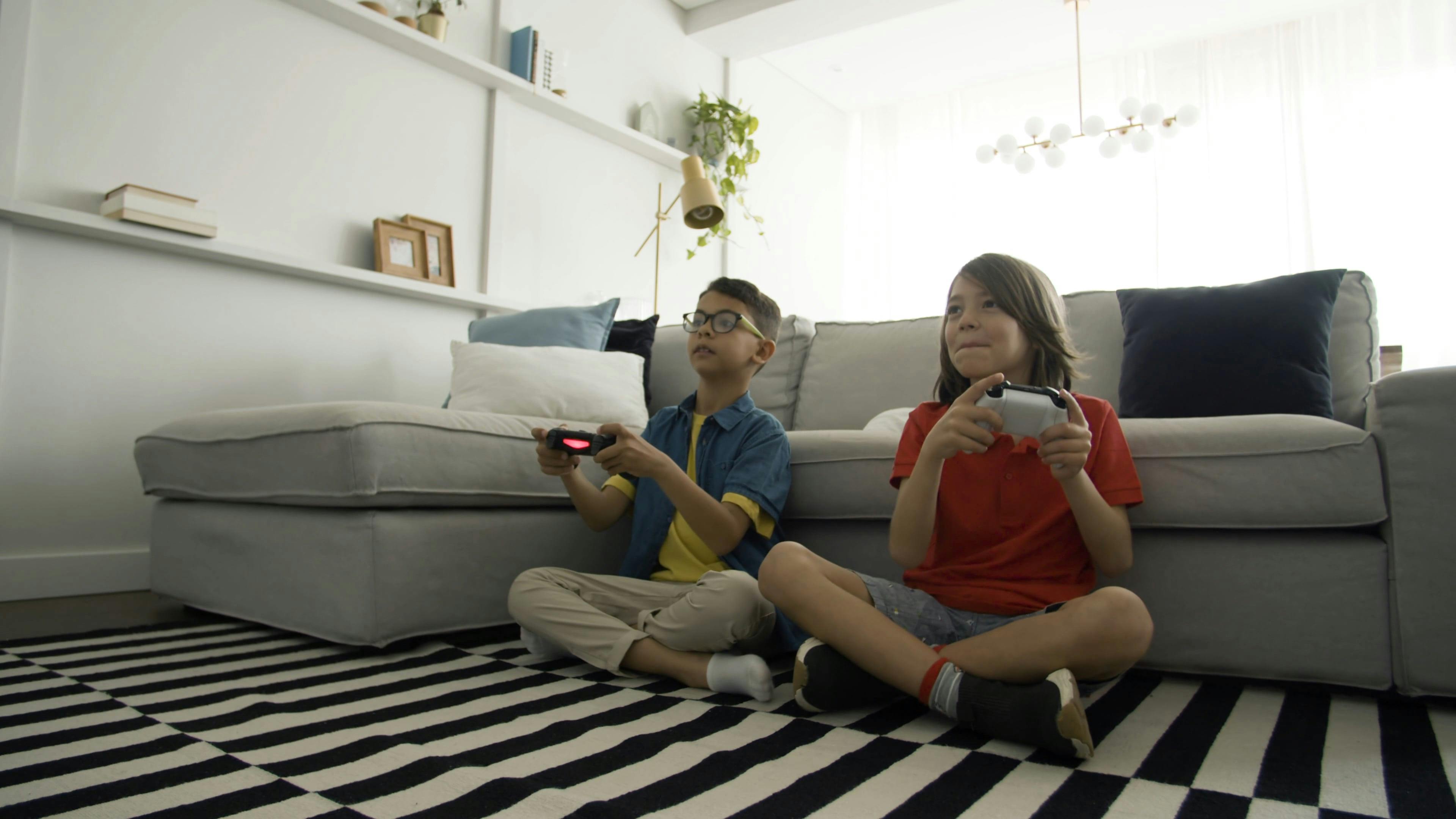 Children Playing Using a Wireless Game Controller · Free Stock Video