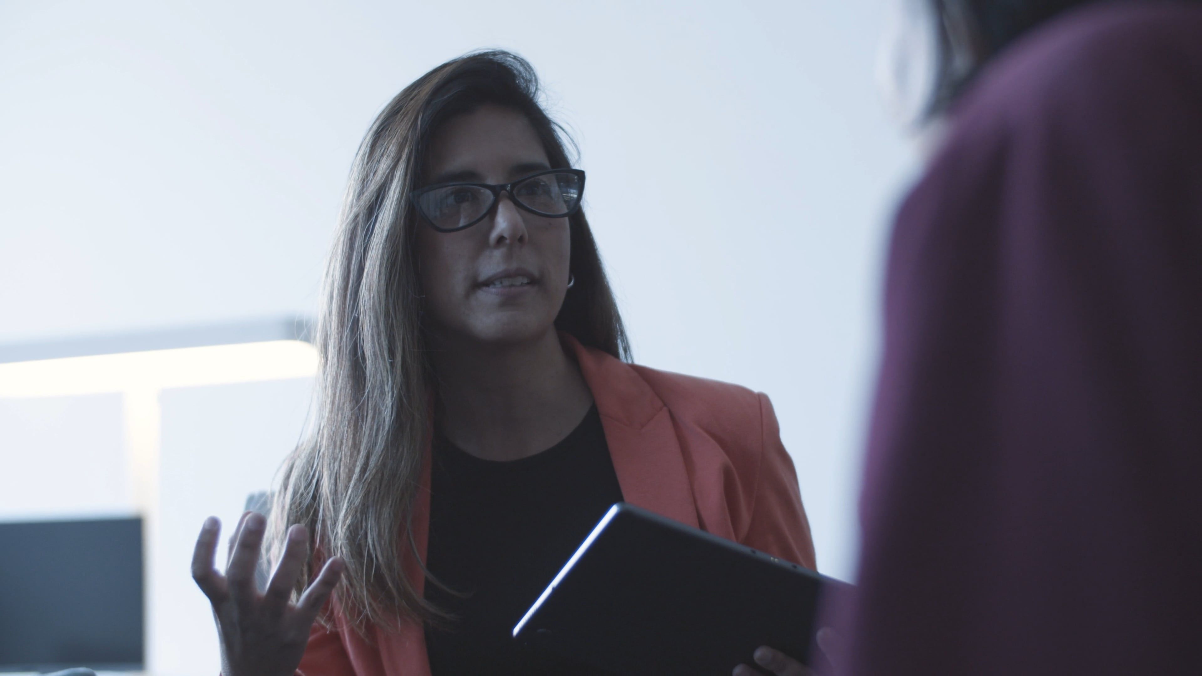 A Woman Doing Hand Gestures while Talking to an Employee · Free Stock Video
