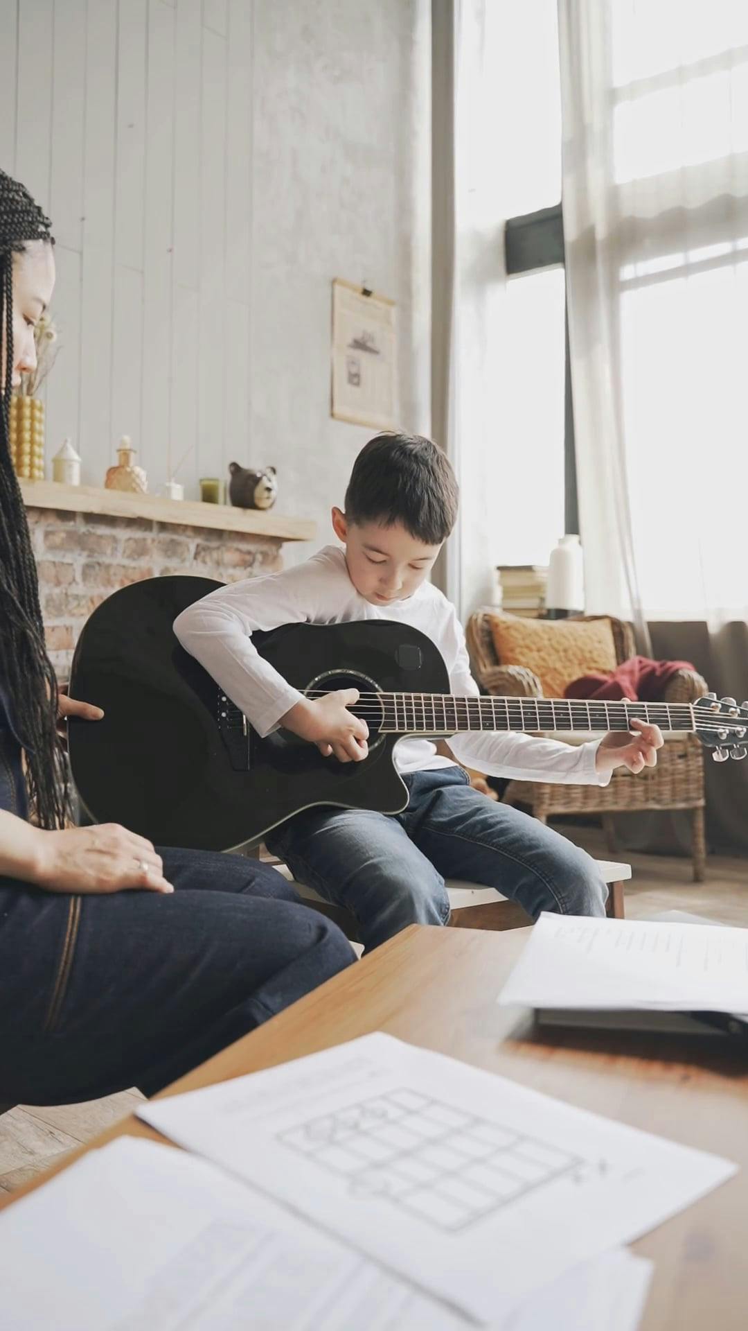 A Boy Learning to Play The guitar · Free Stock Video