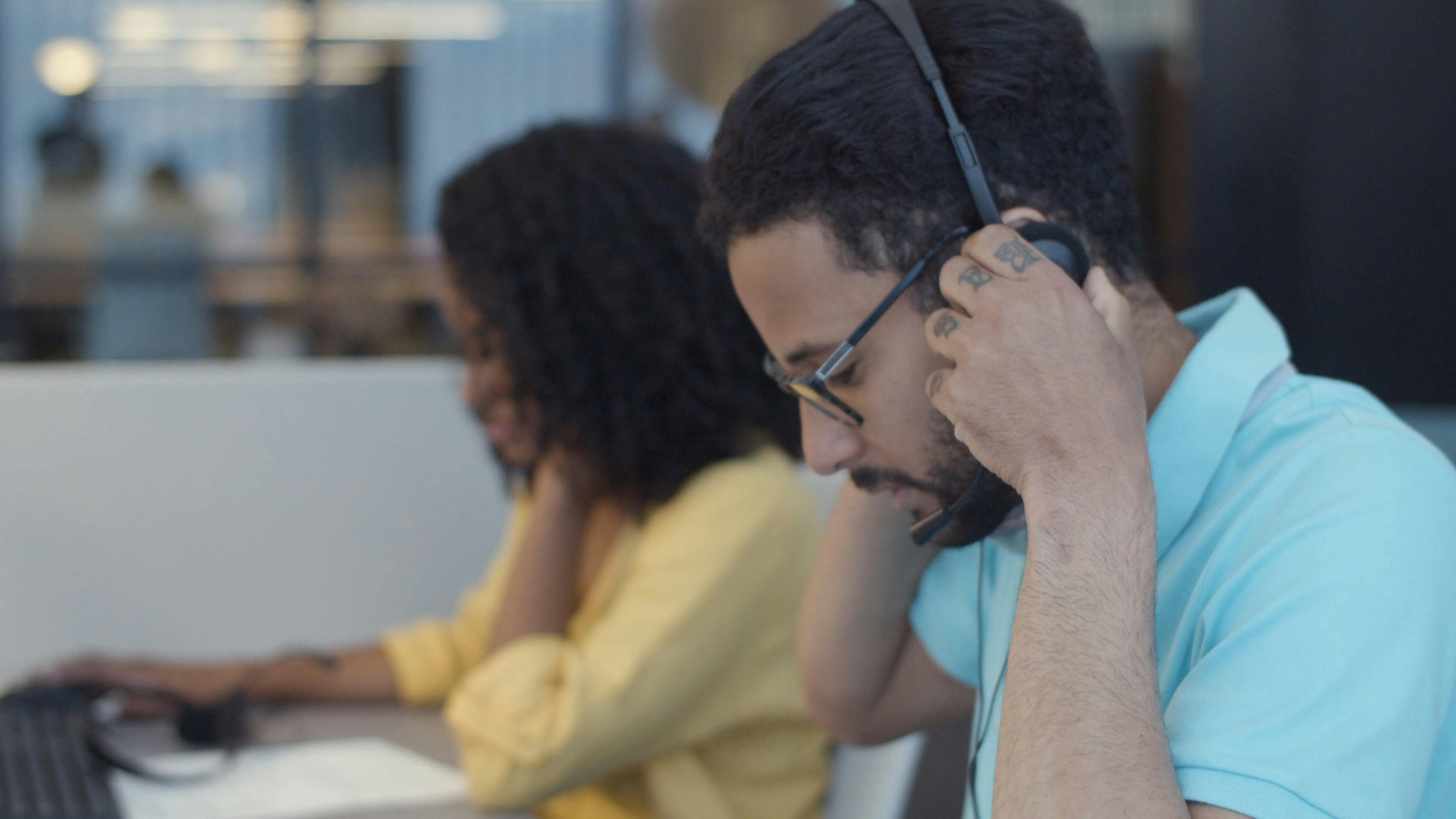 A Man Taking Off His Headphone to Talk on the Phone · Free Stock Video