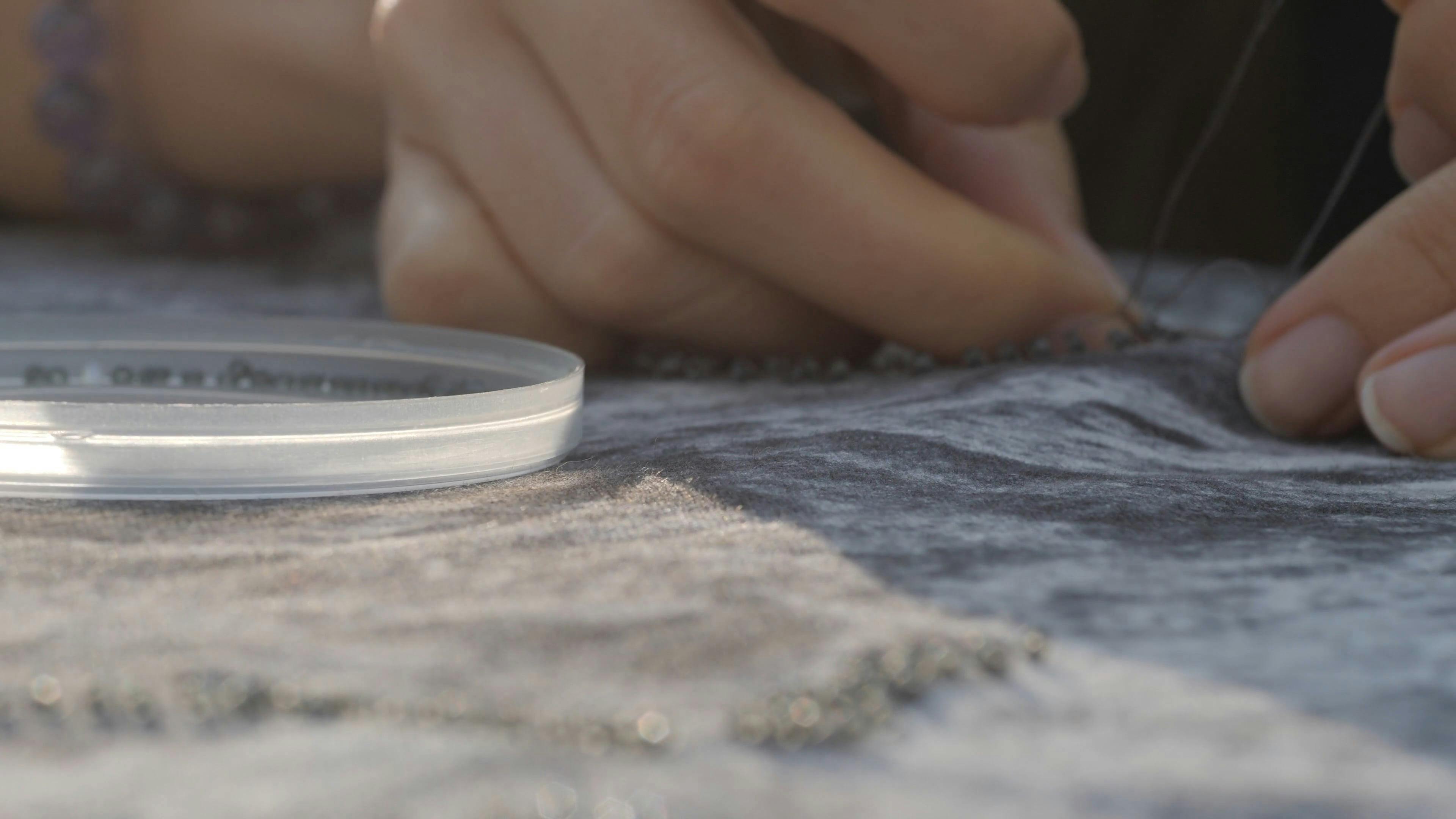 A Person Stitching Beads on a Cloth Free Stock Video Footage, Royalty ...
