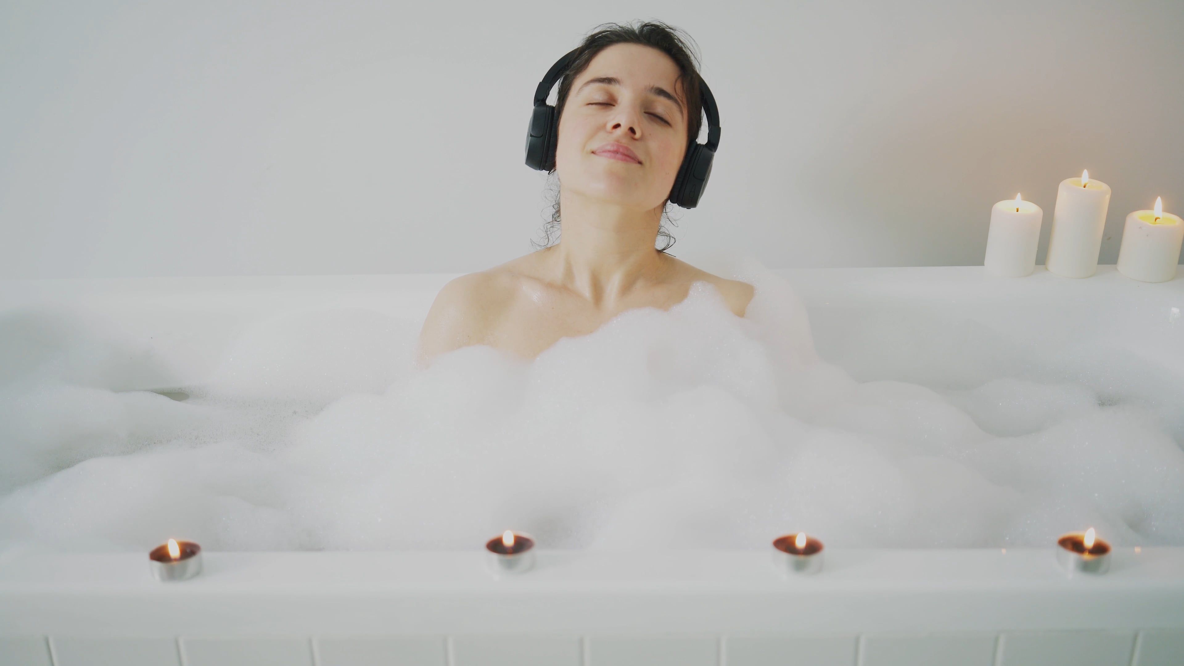 A Woman Listening Music While Relaxes In A Bathtub Free Stock Video ...