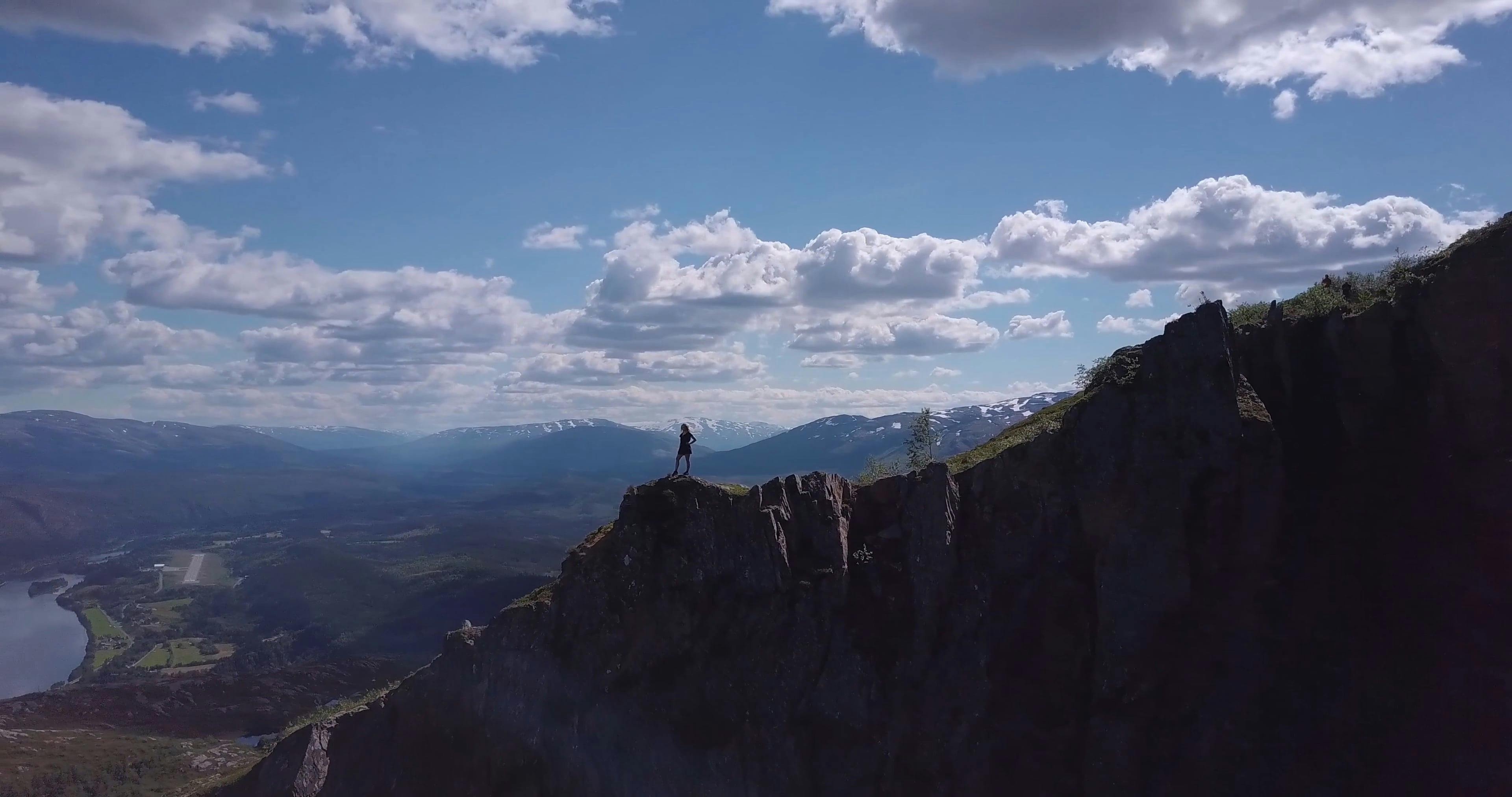 A Person Standing on a Mountain Cliff · Free Stock Video