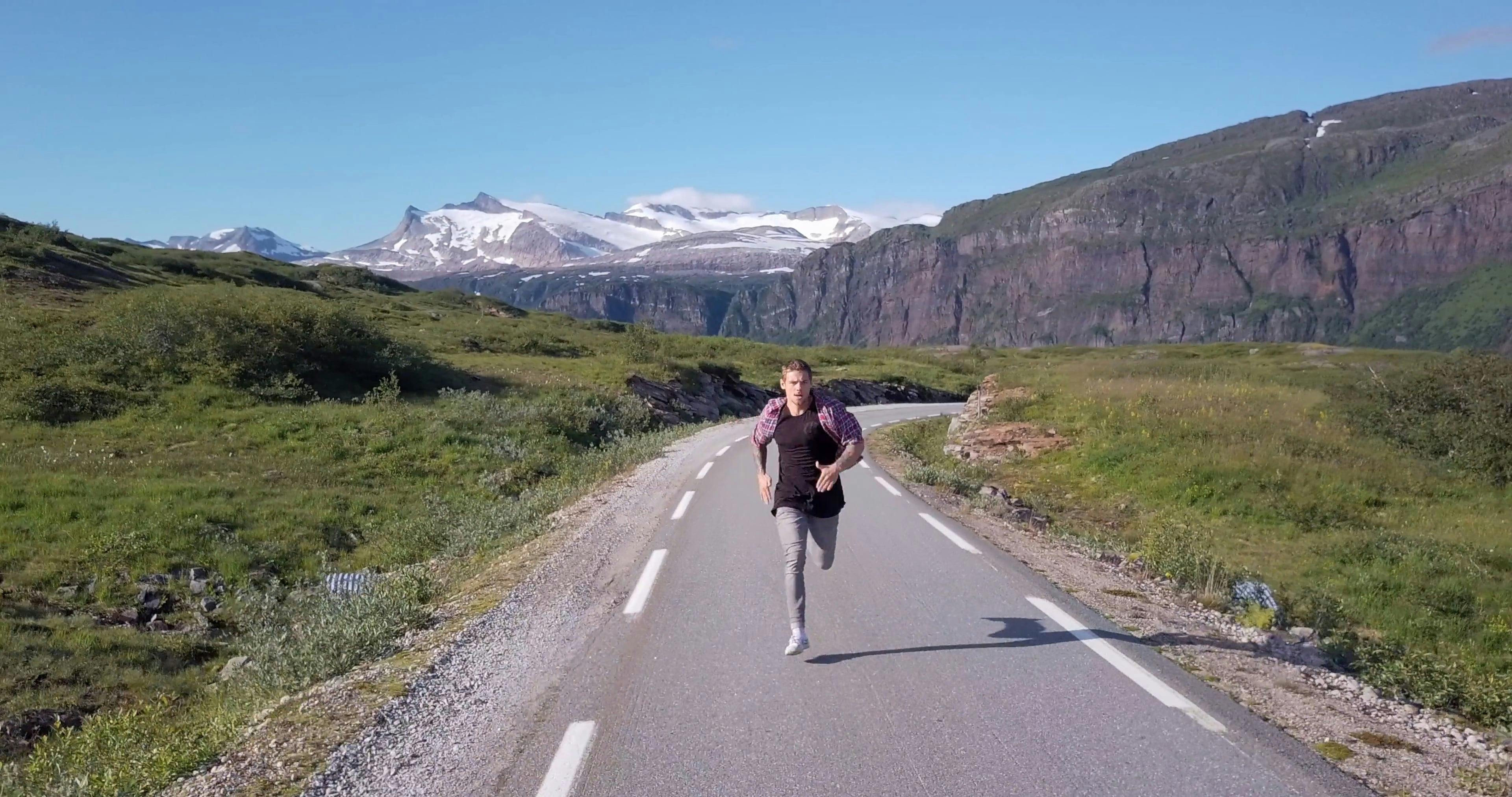 Drone Footage of a Man Running in the Road Free Stock Video Footage ...