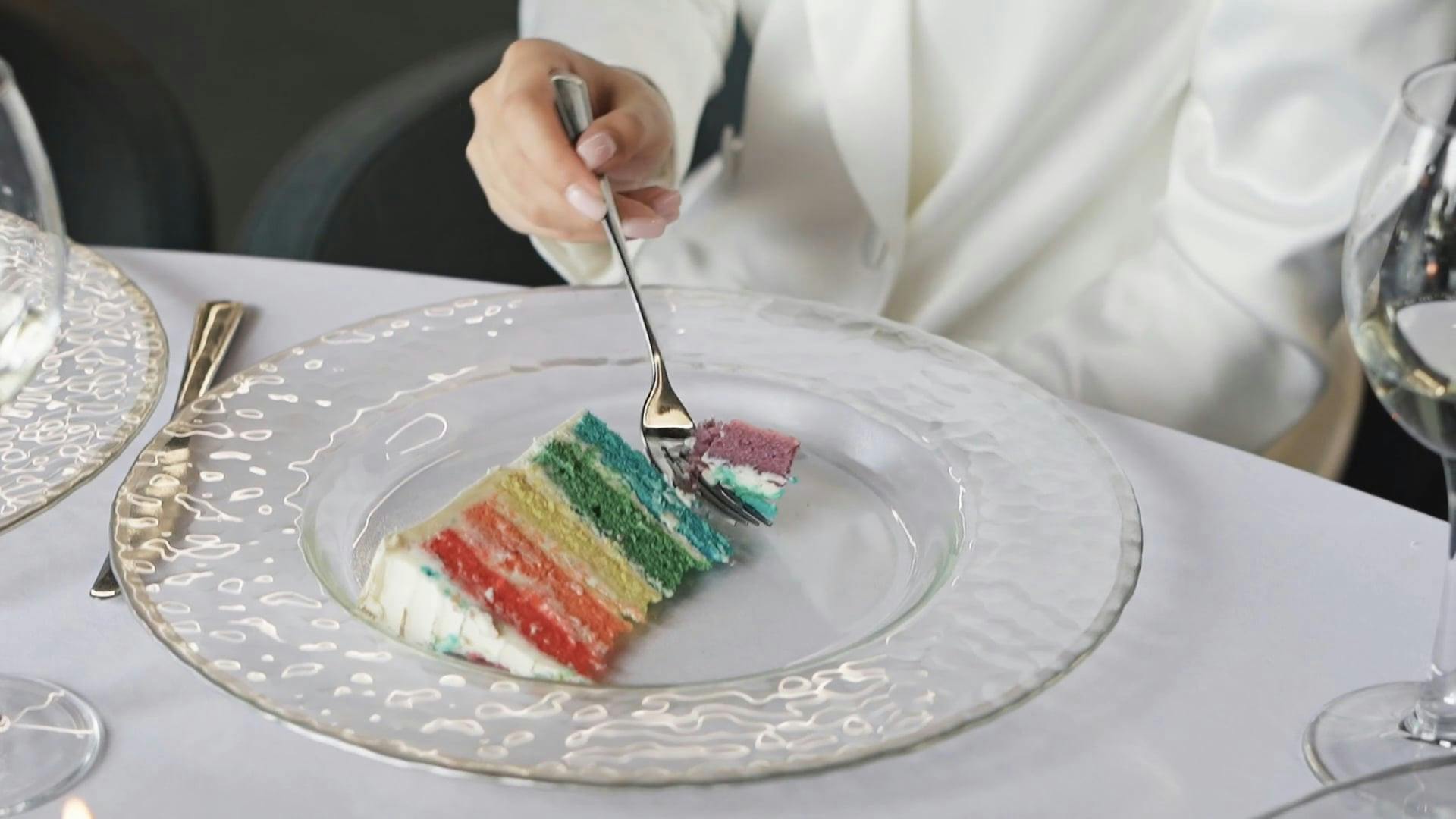 A Woman Feeding the Bride a Rainbow Layer Cake · Free Stock Video