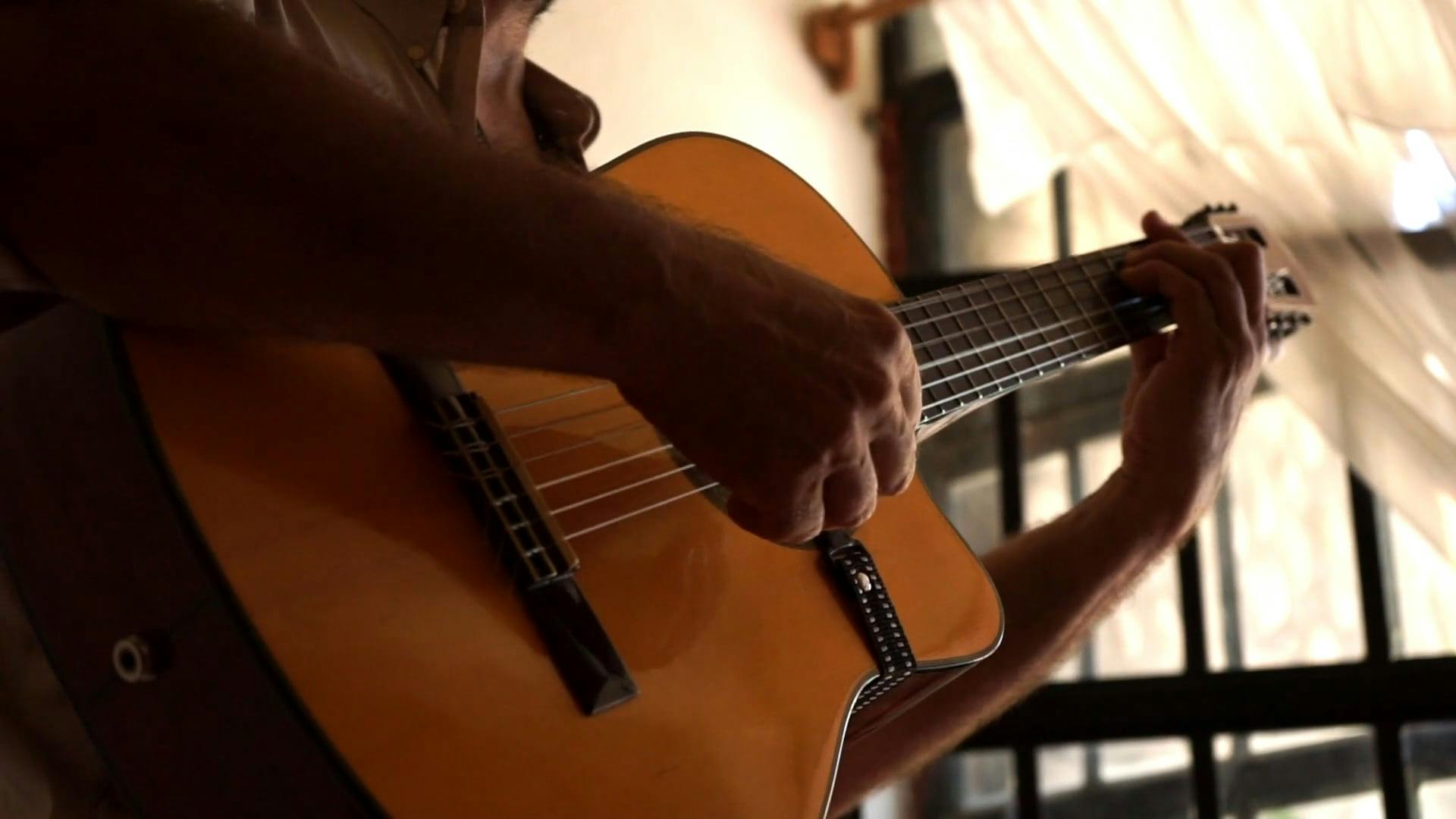 A Person Playing a Guitar · Free Stock Video