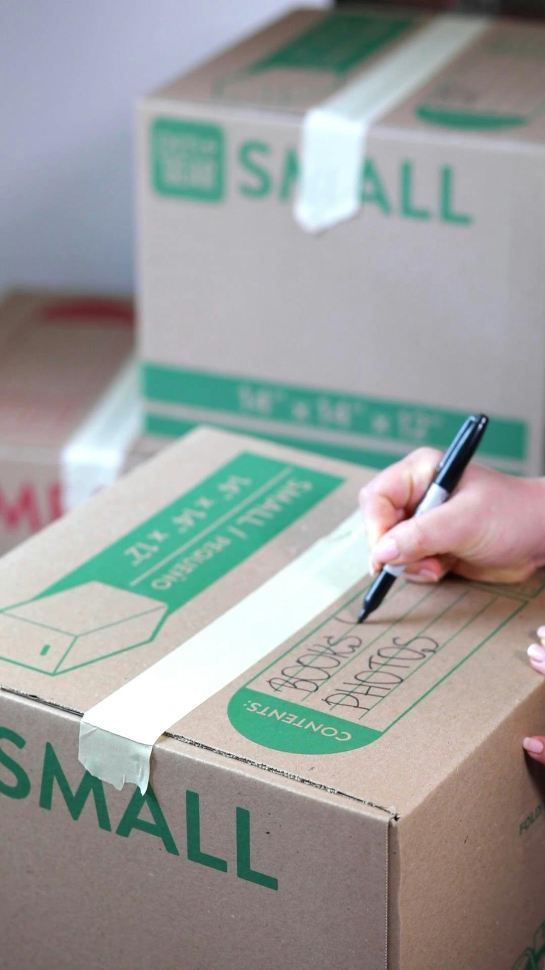 A Person Writing on Packages · Free Stock Video