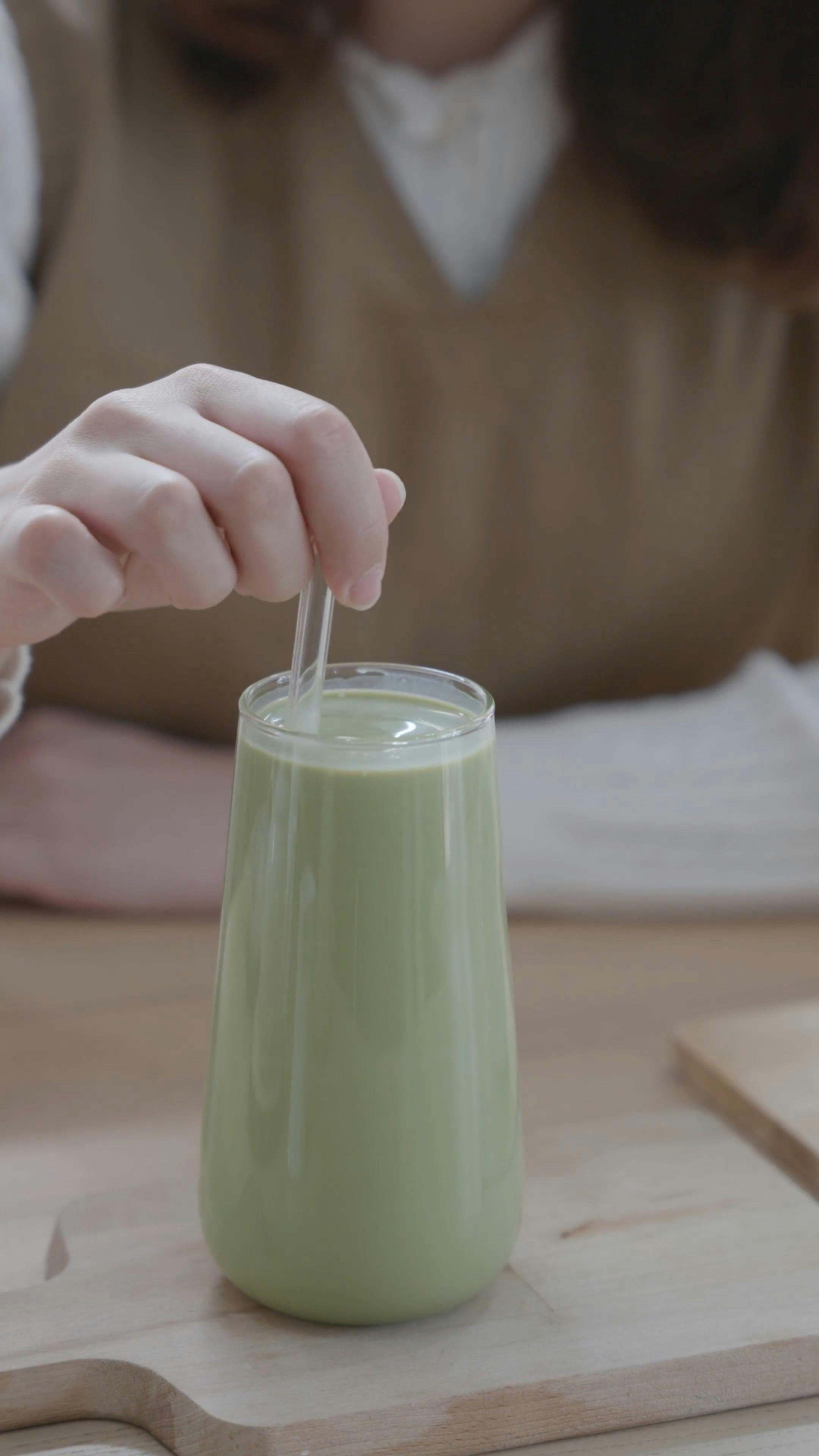 A Woman Stirring Her Drink with a Glass Straw Free Stock Video Footage ...