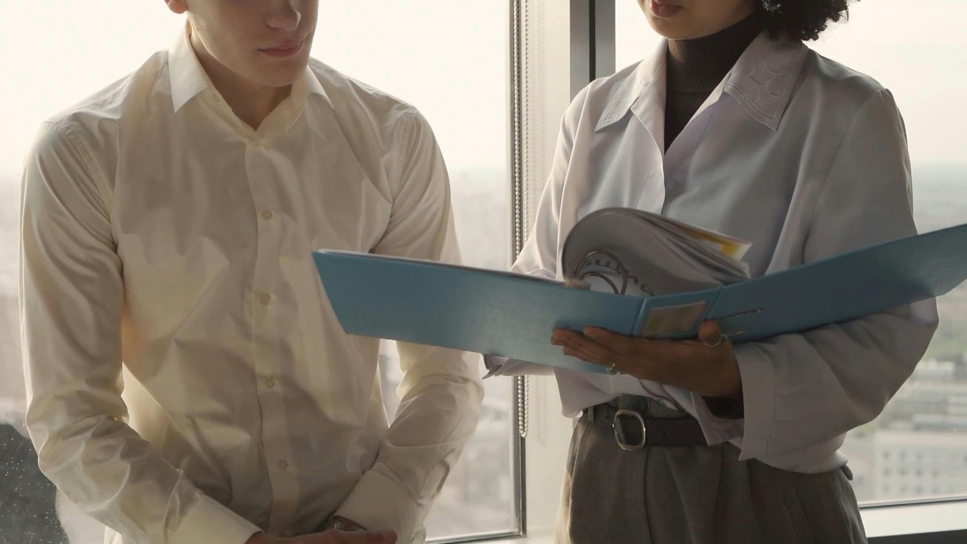 Man and Woman Looking at Documents · Free Stock Video