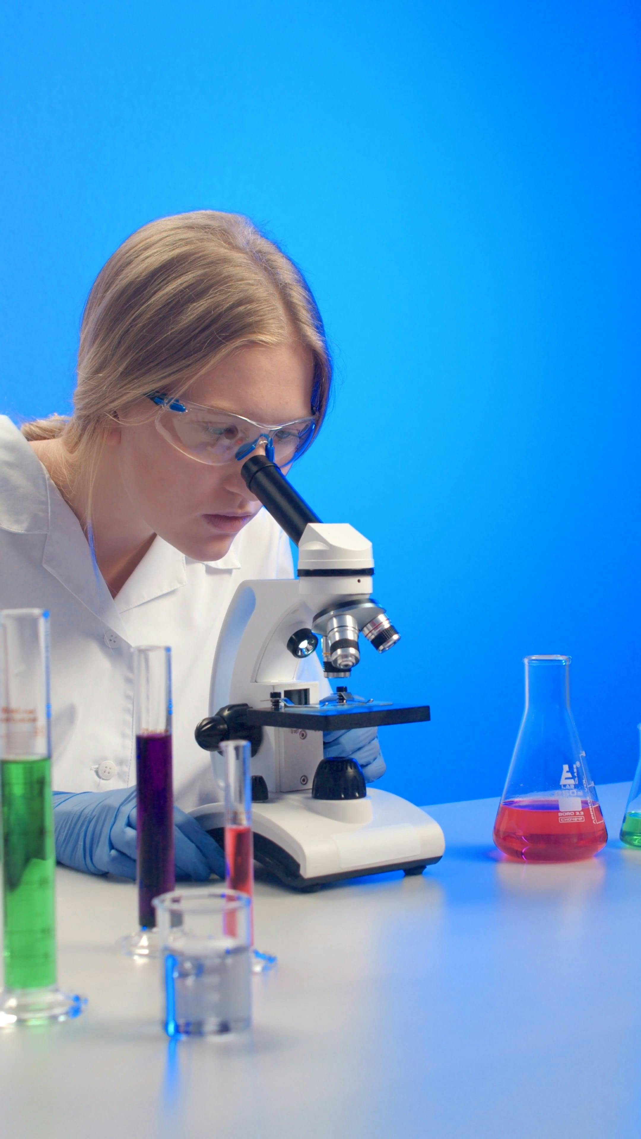 A Woman Observing Specimen Under A Microscope · Free Stock Video