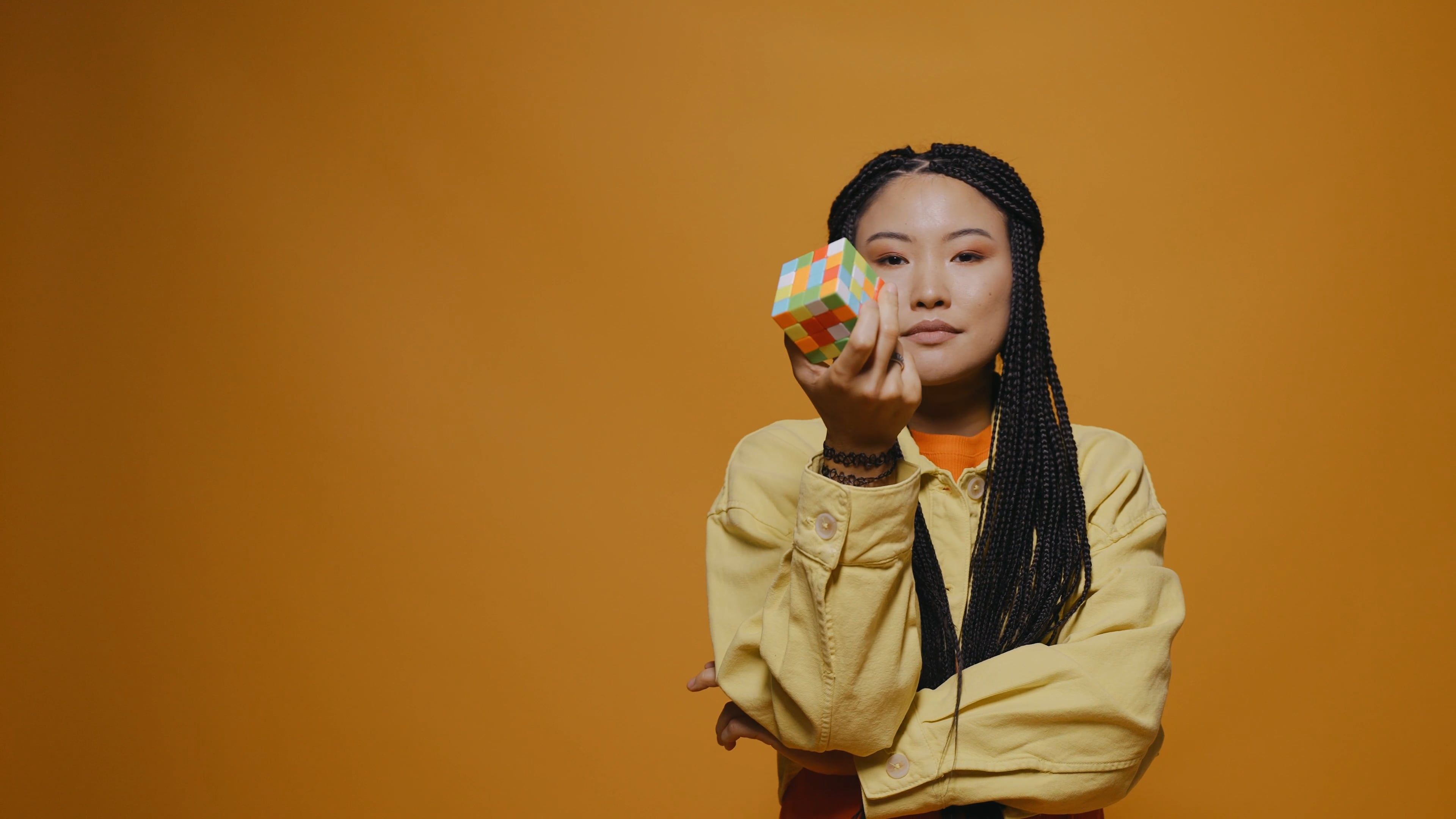 Female Model Throwing a Rubik's Cube · Free Stock Video