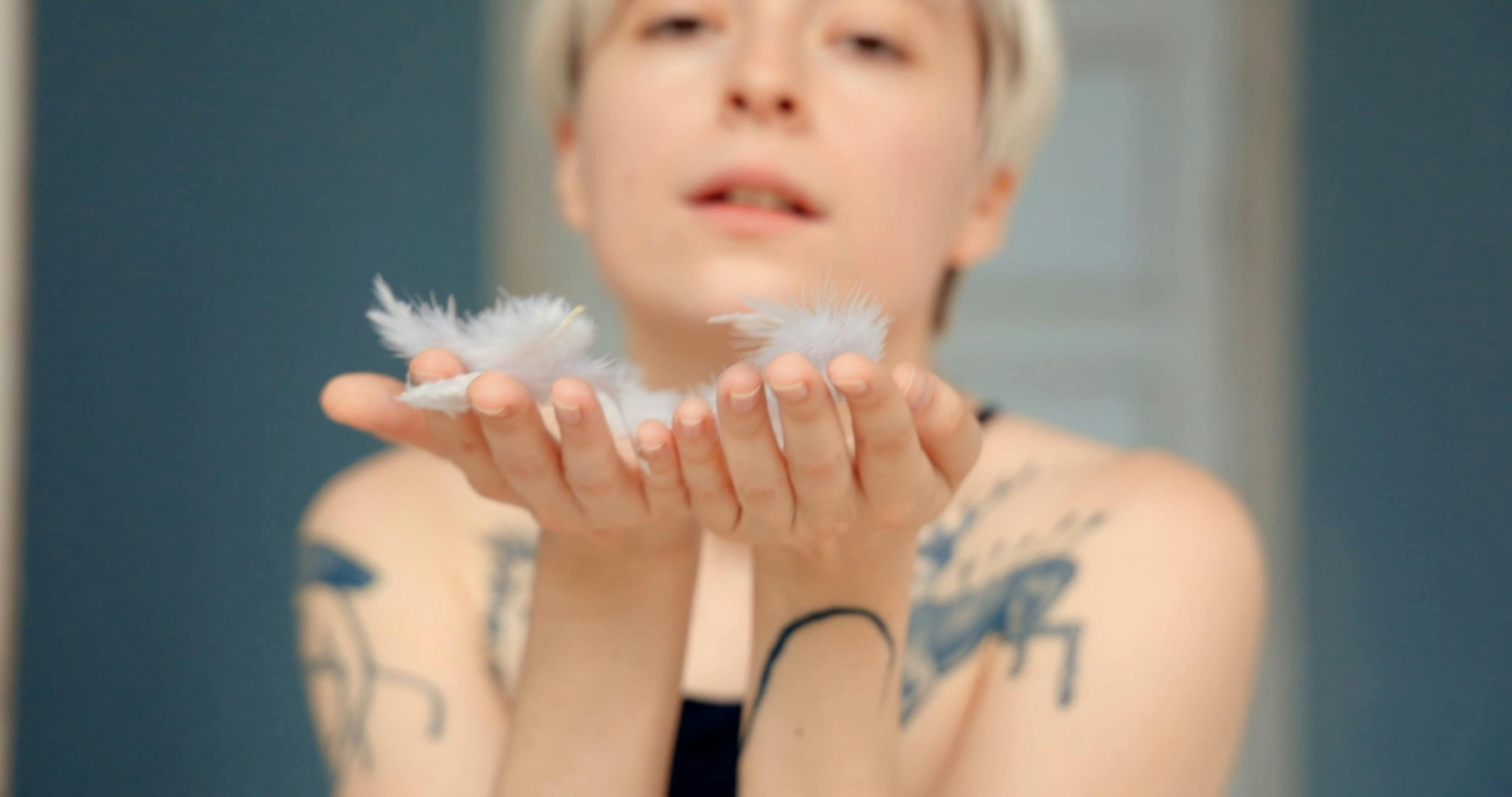 Woman Blowing Feathers from Her Hands Free Stock Video Footage, Royalty ...
