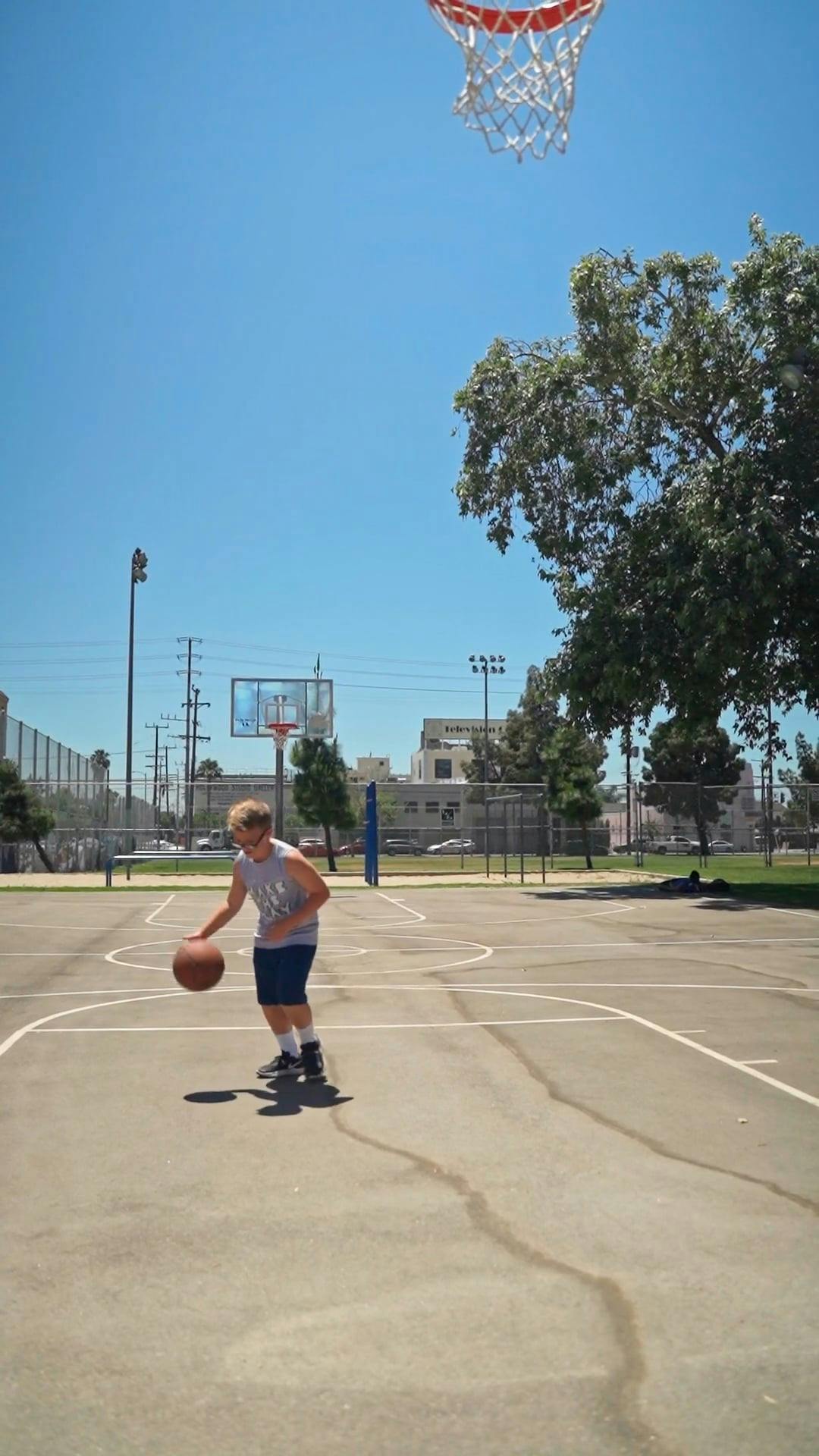 A Basketball Player Shooting The Ball In A Reverse Layup Free Stock ...