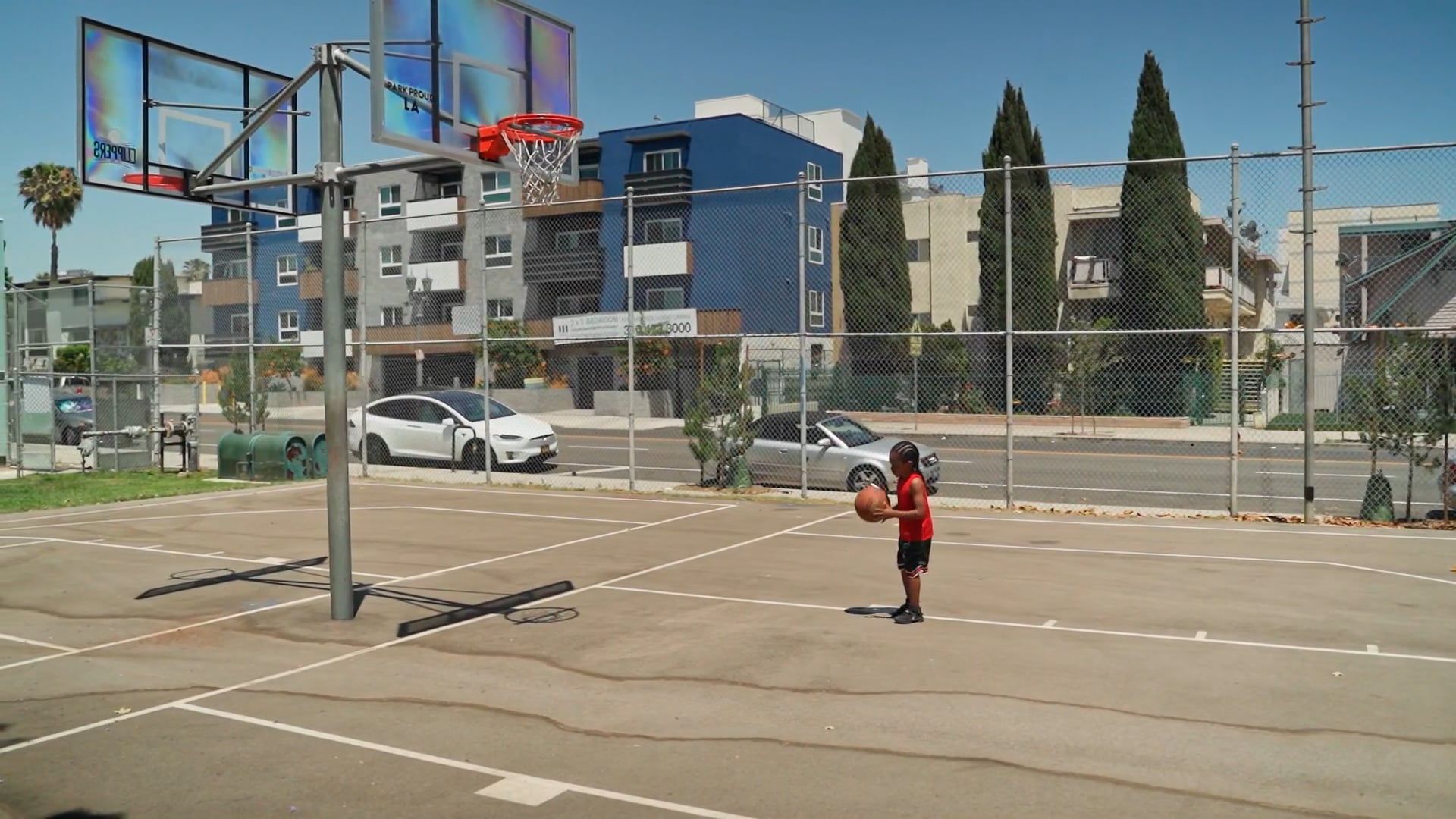 A Kid Throwing a Basketball on a Backboard · Free Stock Video
