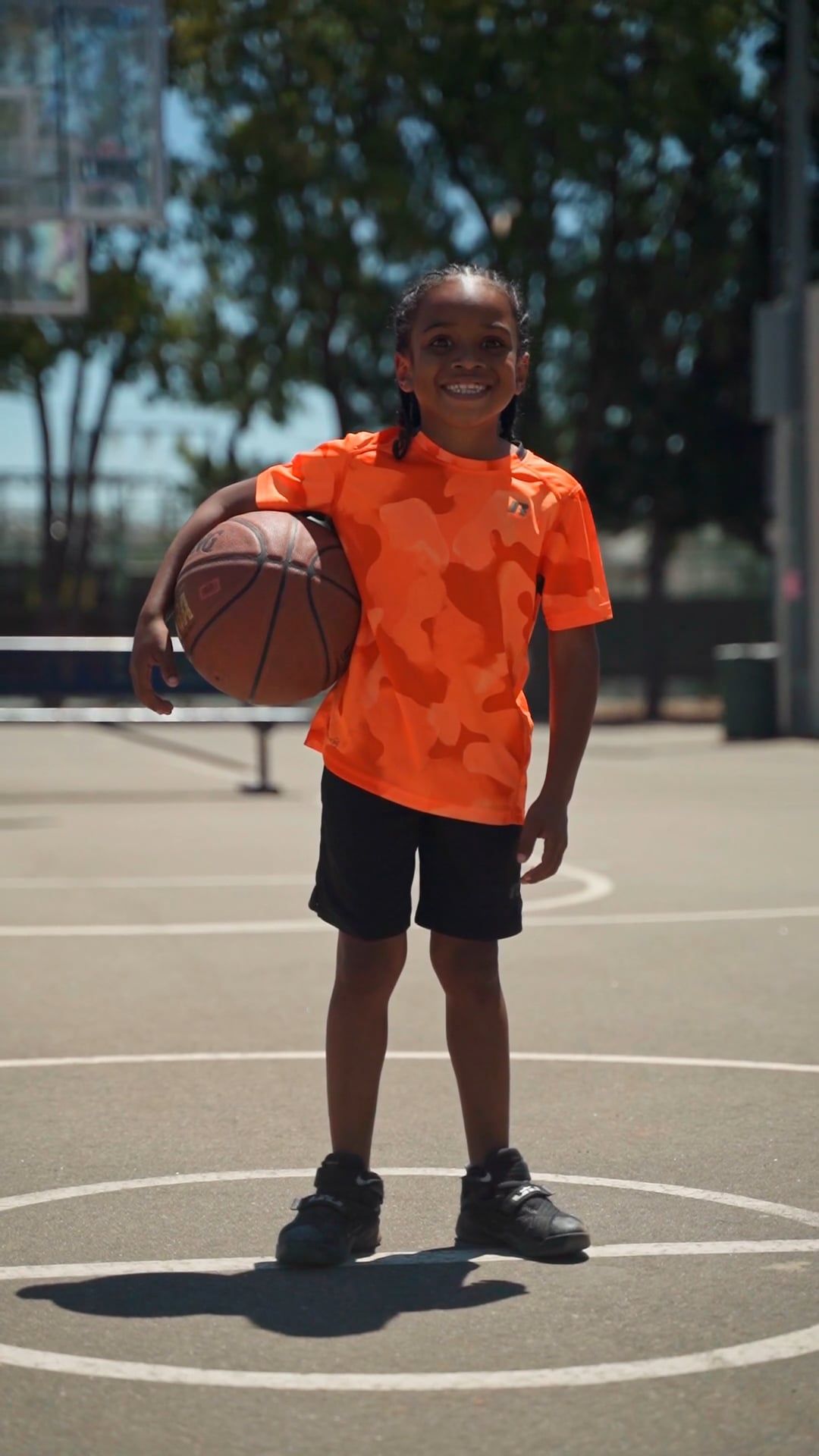 Little Boy Carrying a Ball while Standing on a Basketball Court Free ...