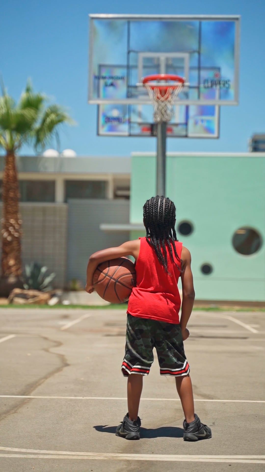 Little Boy Carrying a Ball while Standing on a Basketball Court Free ...