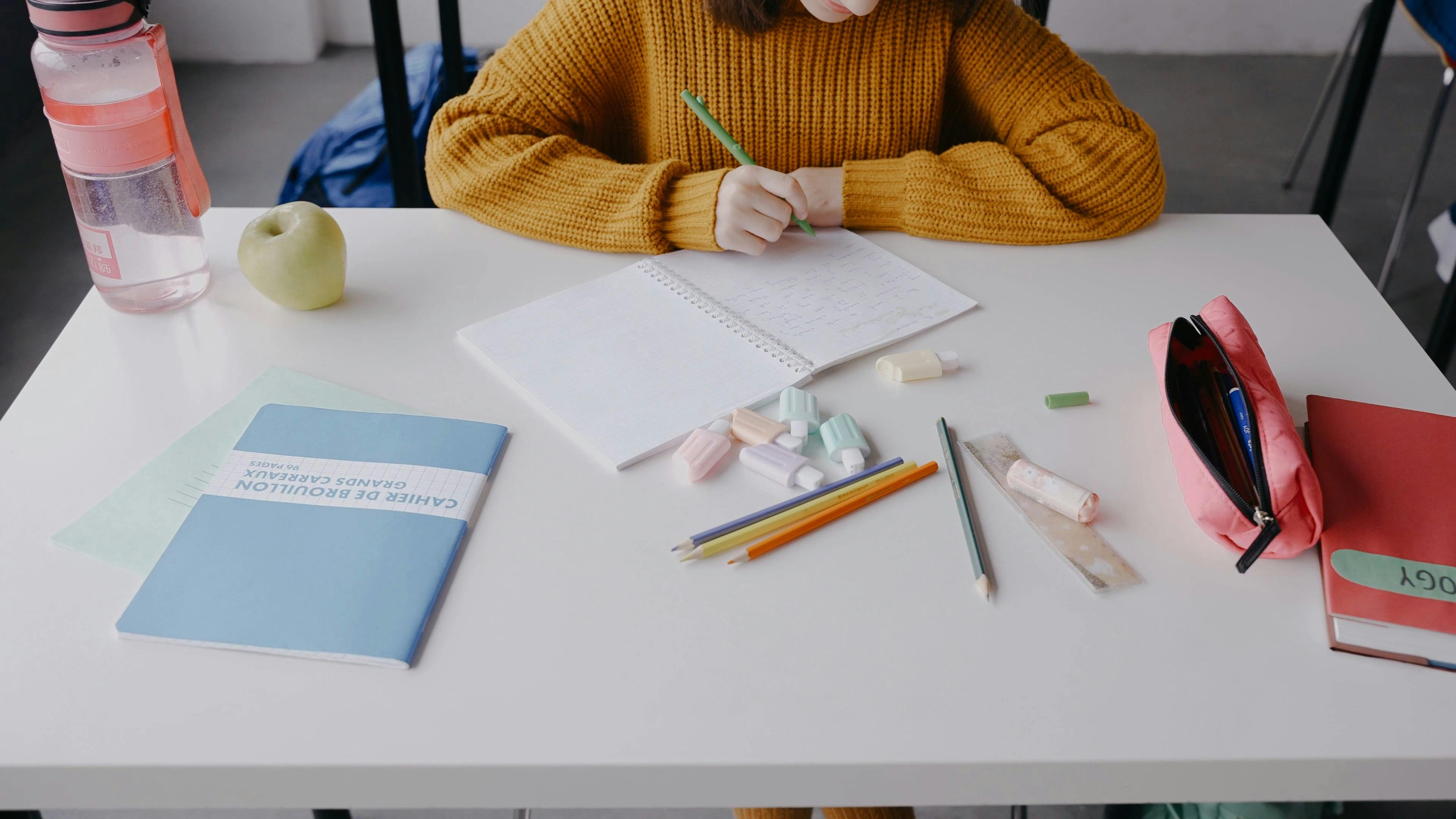 Female Student Writing on Her Notebook · Free Stock Video