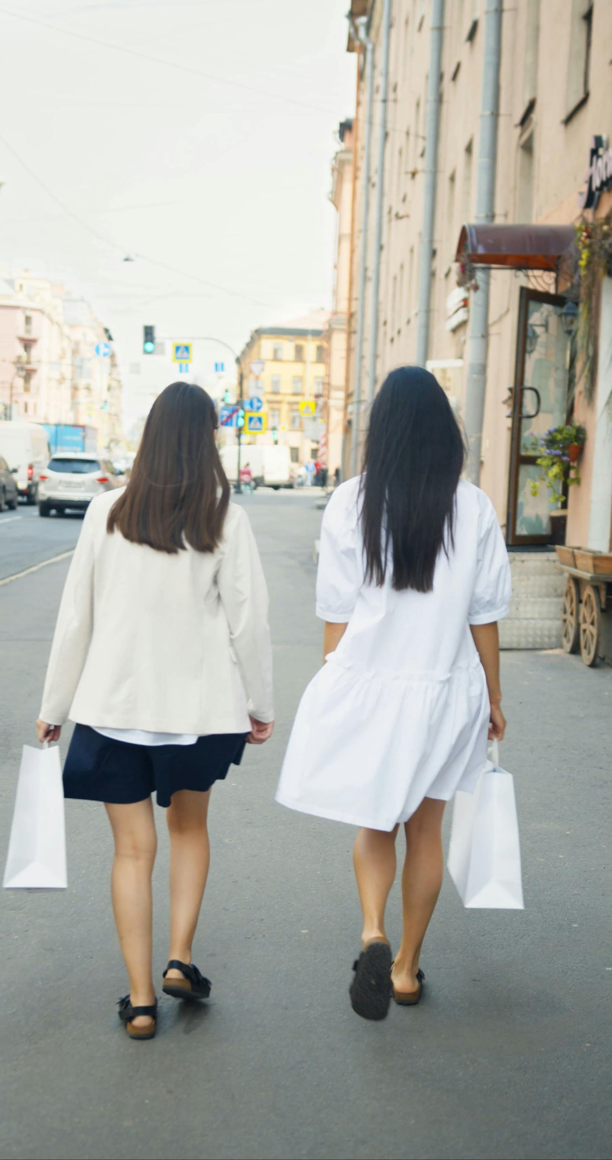 Back View of Women Walking in the Pavement Beside the Buildings · Free ...