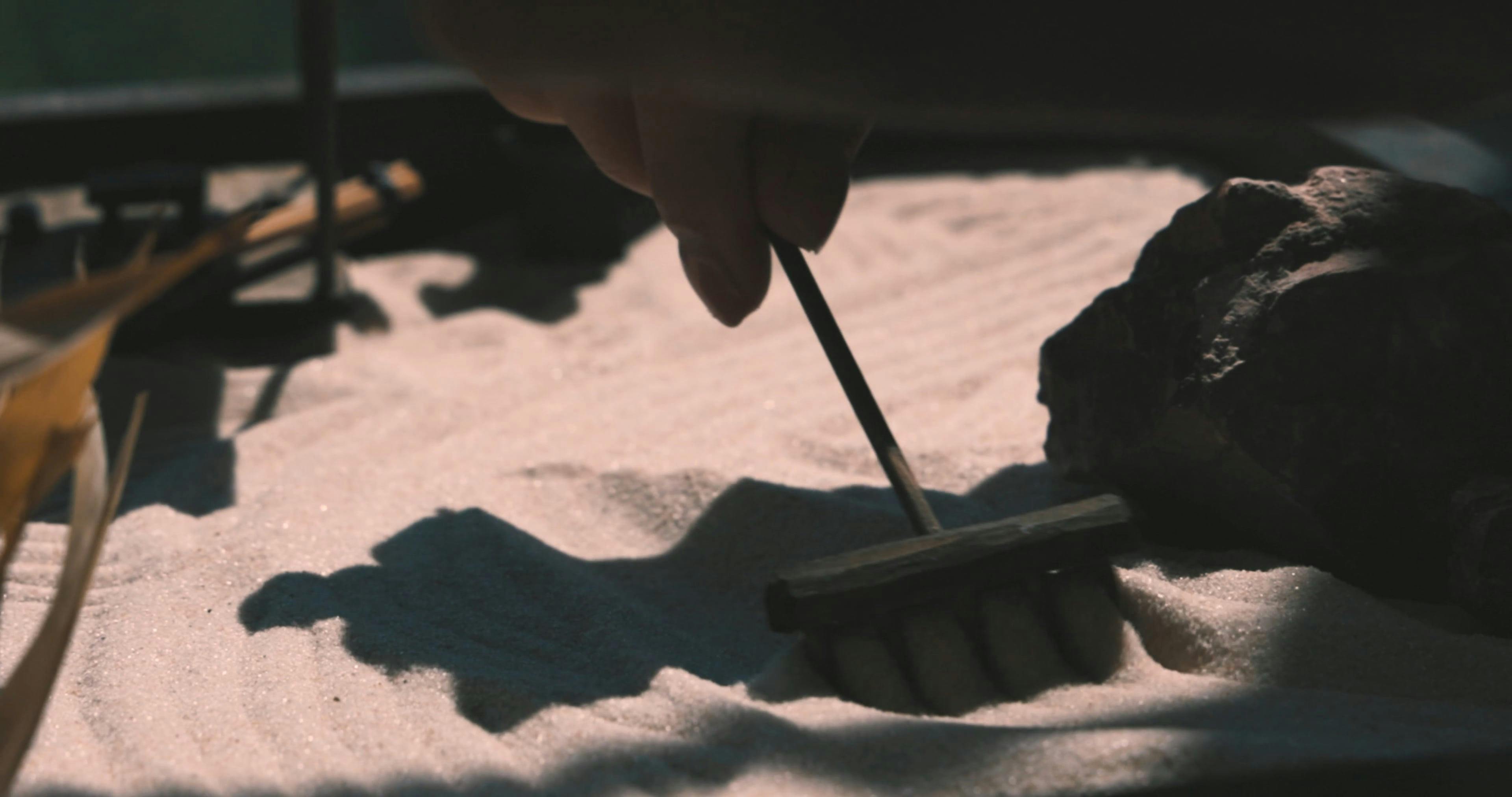 A Person Raking the Sand on a Miniature Zen Garden Free Stock Video ...