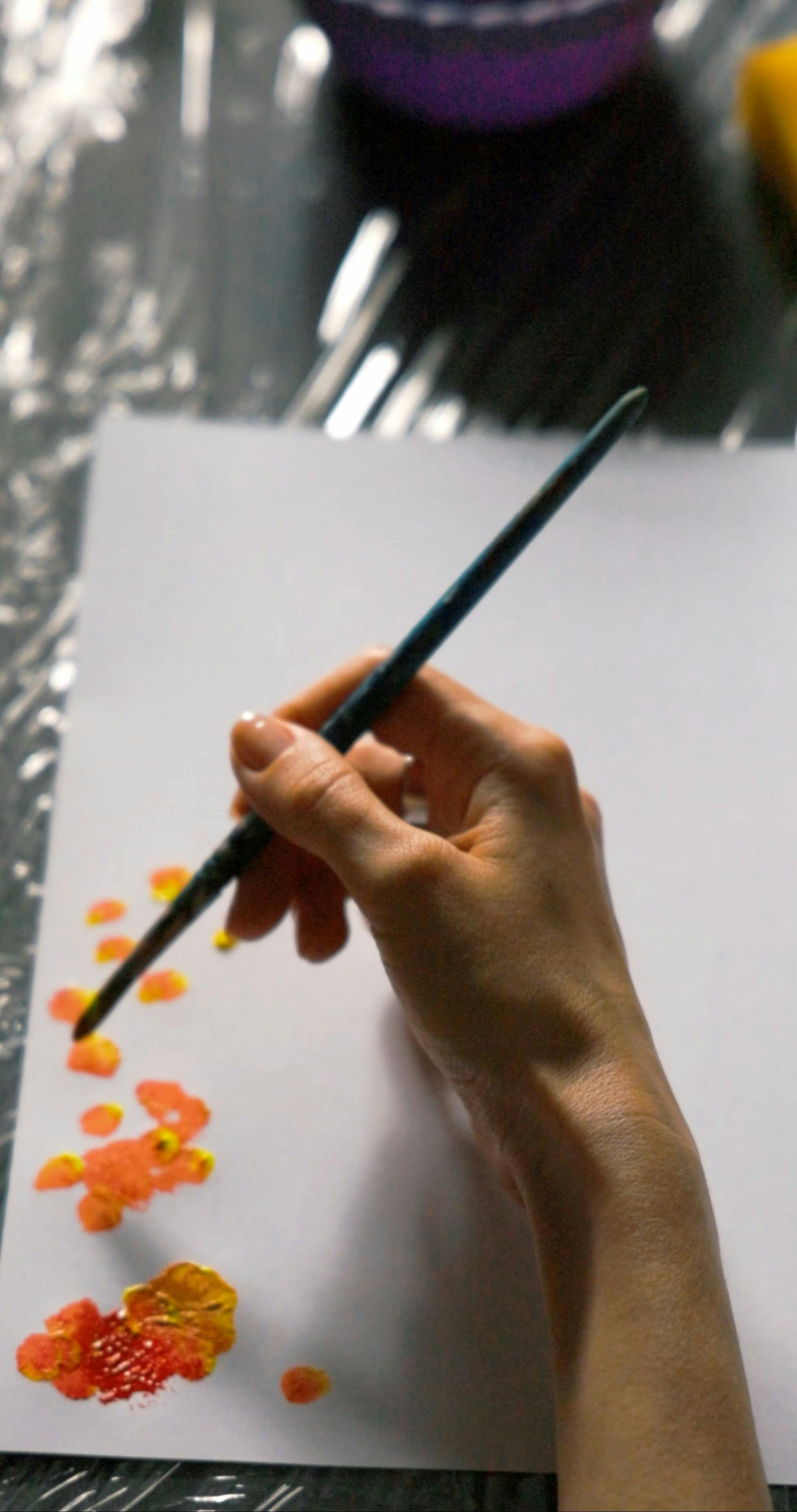 Person Painting on a Paper · Free Stock Video