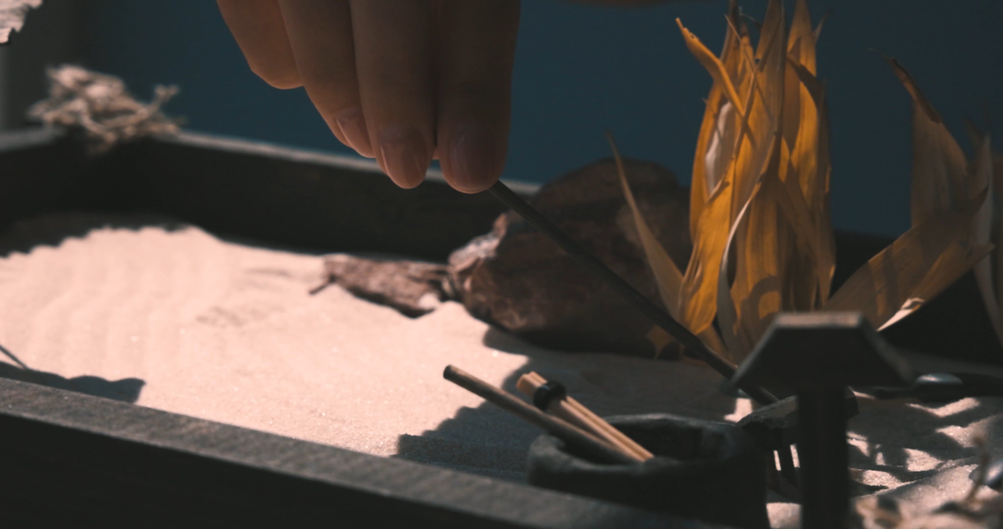 Close up of a Person using a Rake in a Mini Zen Garden Free Stock Video ...