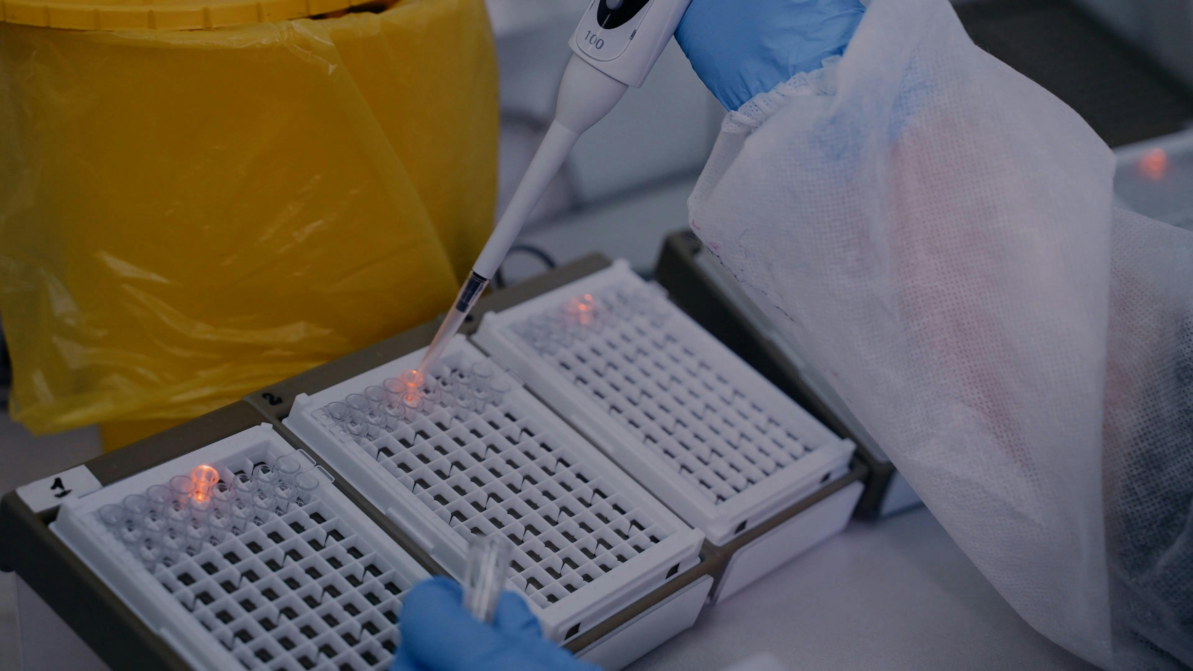 A Person Using a Micropipette in a Laboratory · Free Stock Video