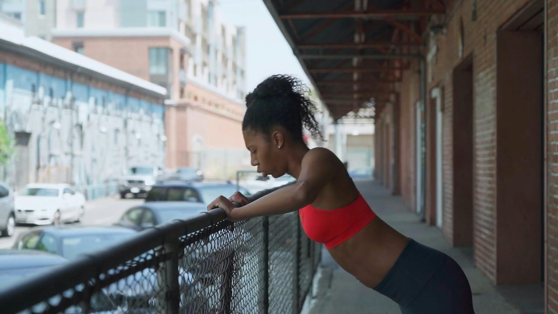 A Woman Doing Push Ups On A Metal Fence Free Stock Video