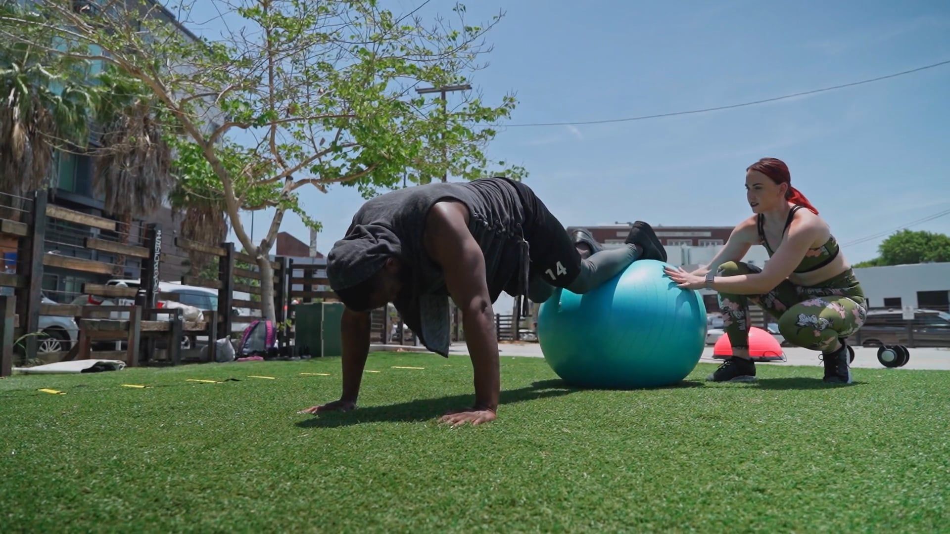 A Personal Trainer Coaching a Man Using an Exercise Ball Free Stock ...