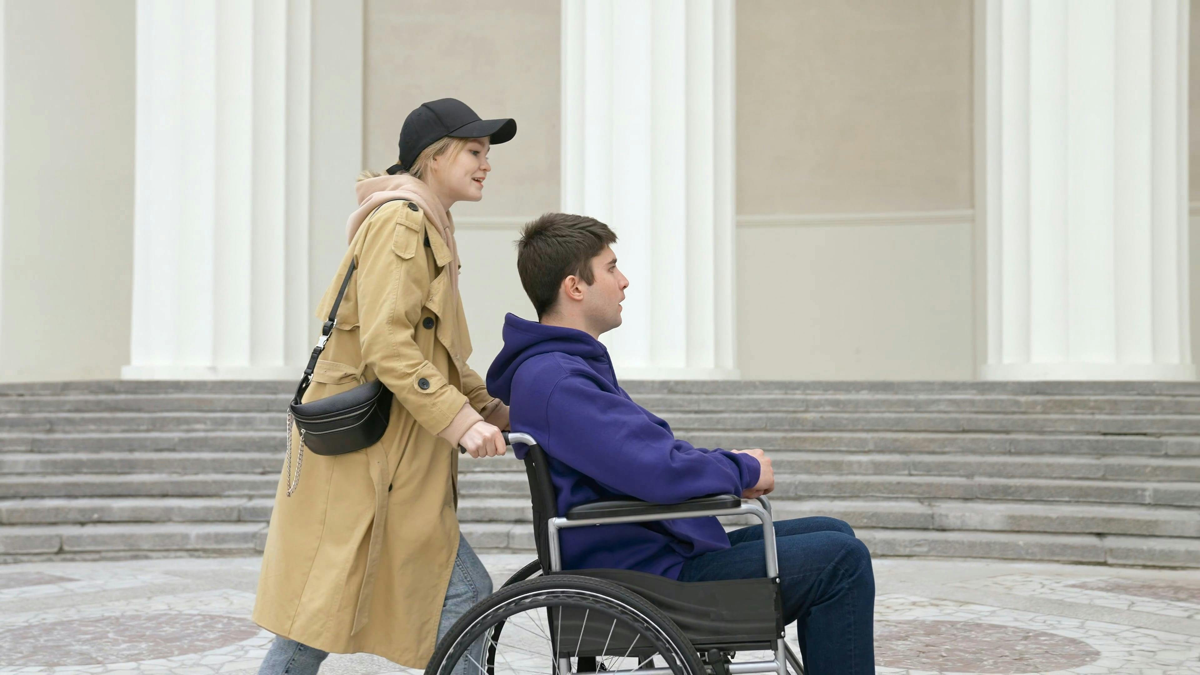 A Female Pushing a Person on a Wheelchair Free Stock Video Footage ...