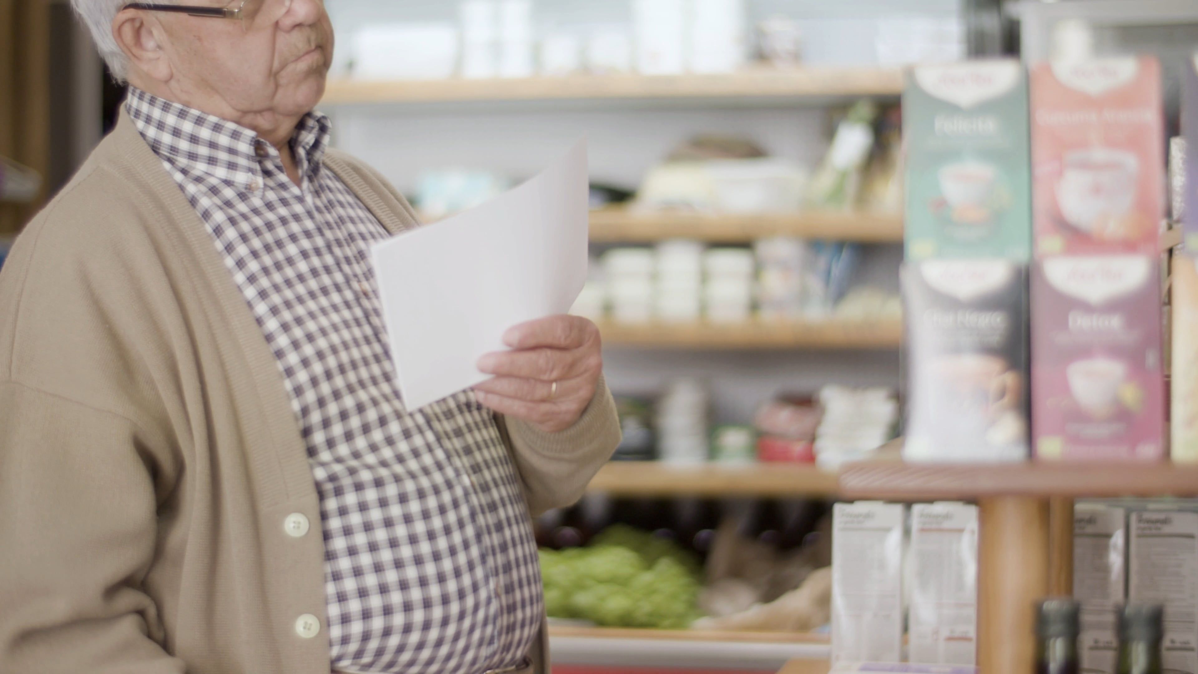 Man Looking at a Product Inside a Supermarket · Free Stock Video