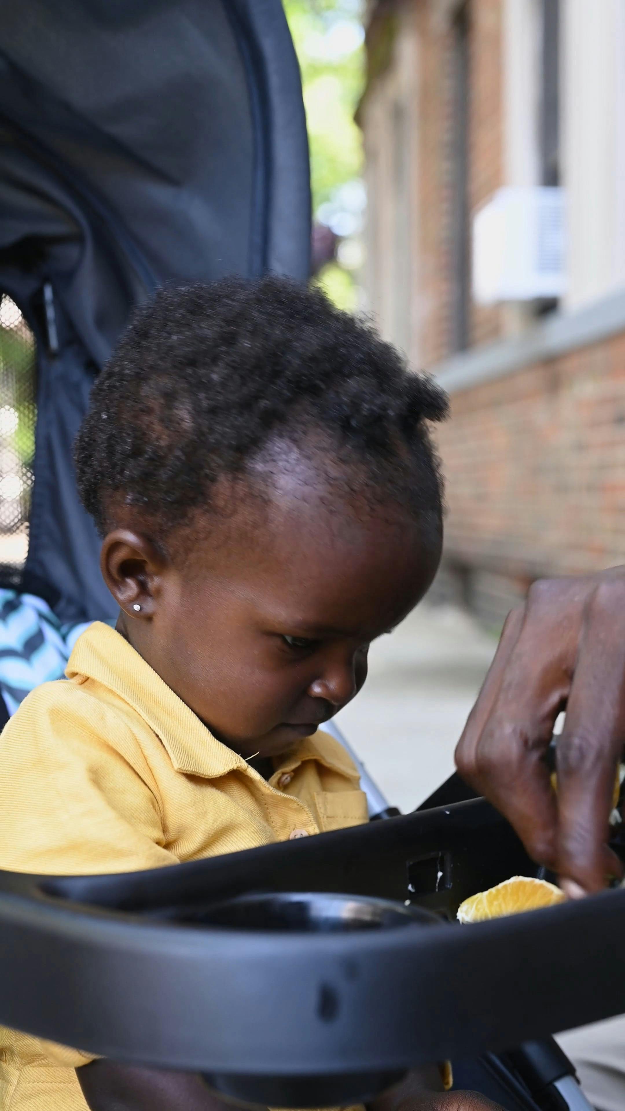 Baby Sitting in a Stroller Using a Pacifier · Free Stock Video