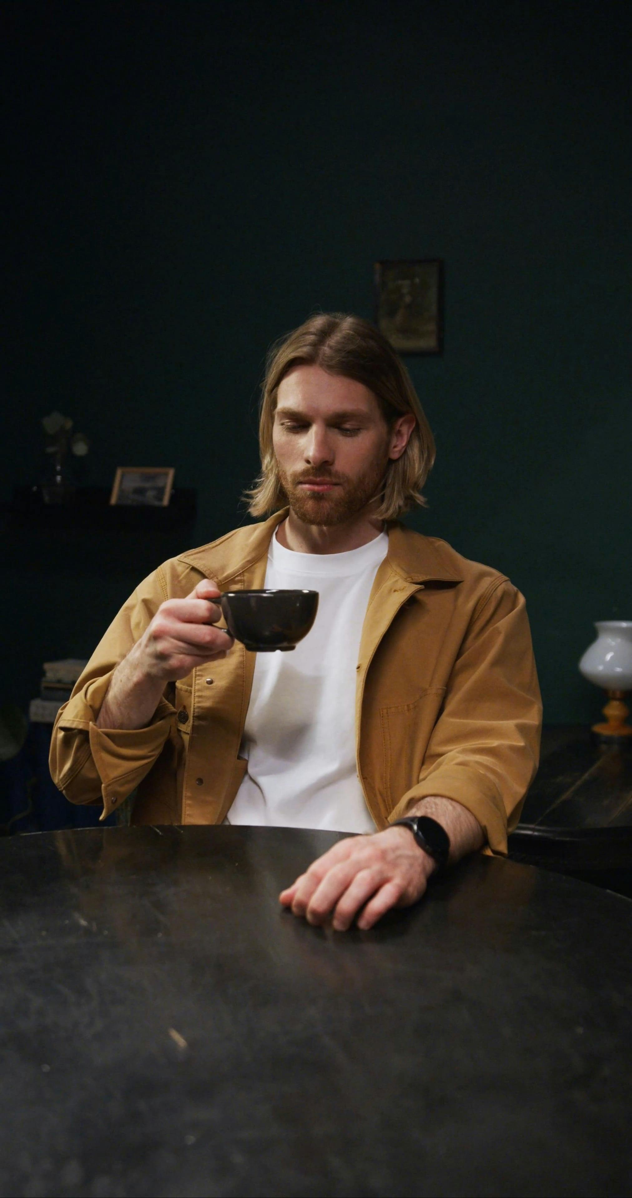A Man Putting a Cup of Coffee Down on a Table Free Stock Video Footage ...