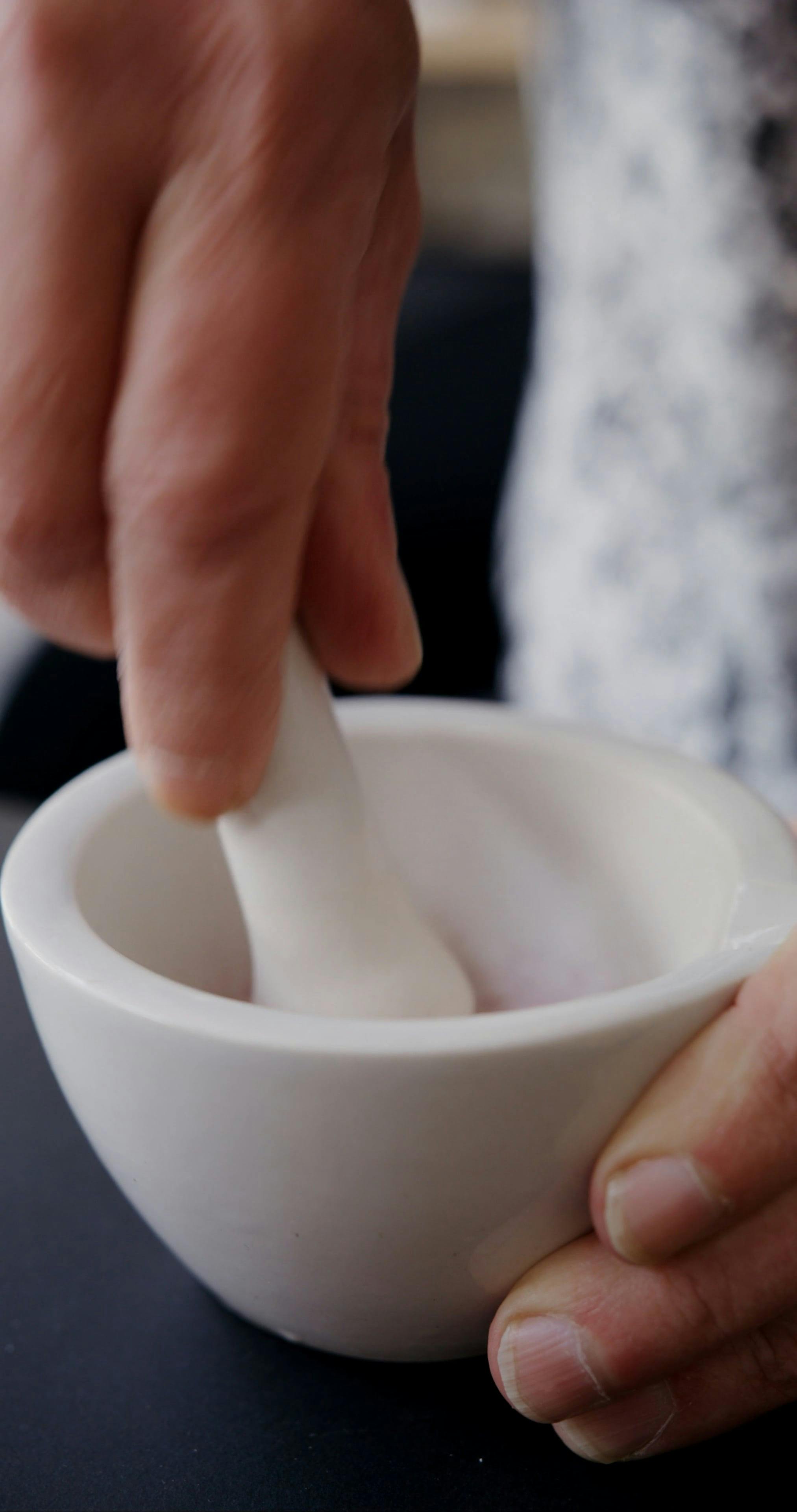 Grinding Ingredients Using a Mortar and Pestle · Free Stock Video